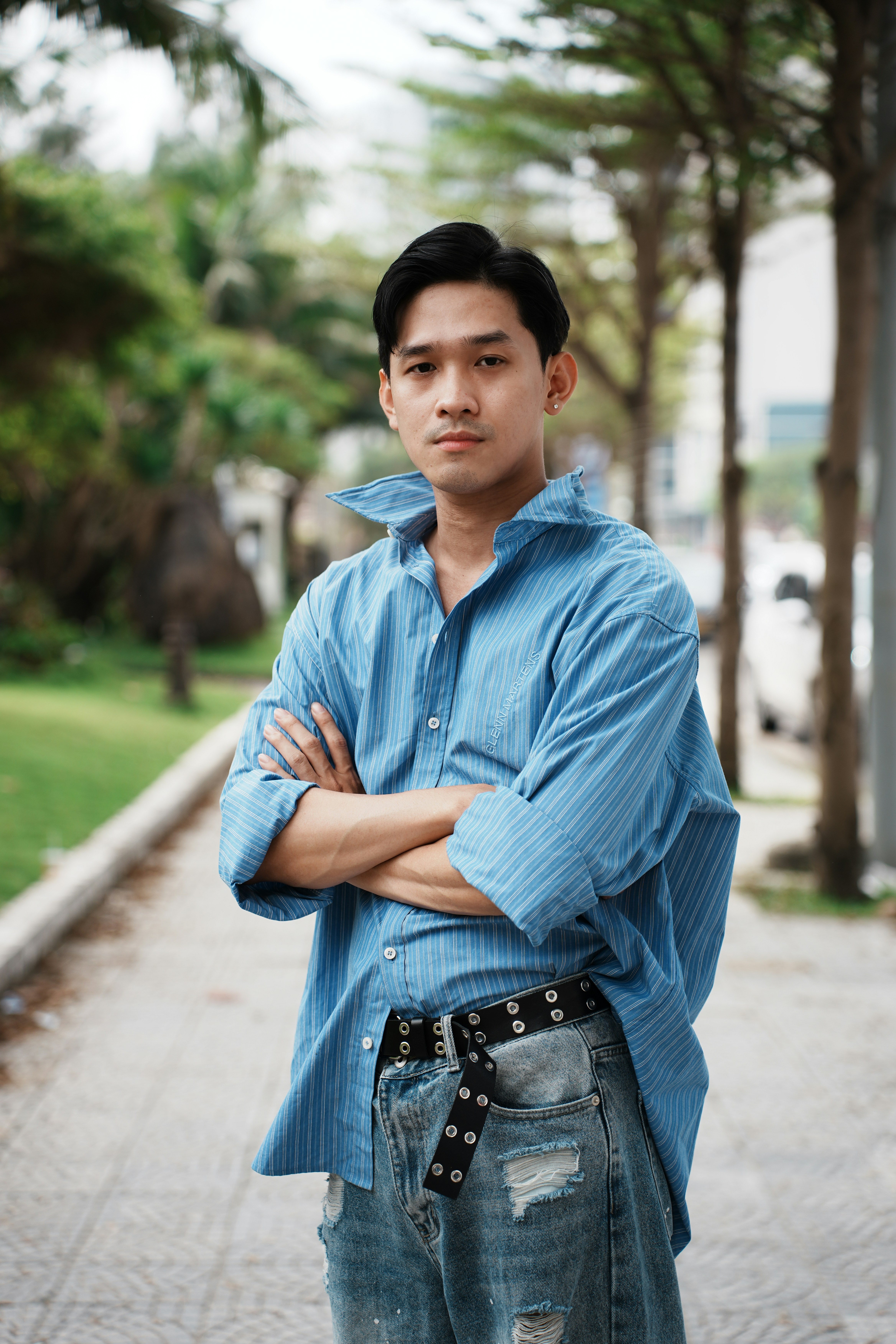 Crossed Arms, Confident Gaze: Urban Portrait in Blue