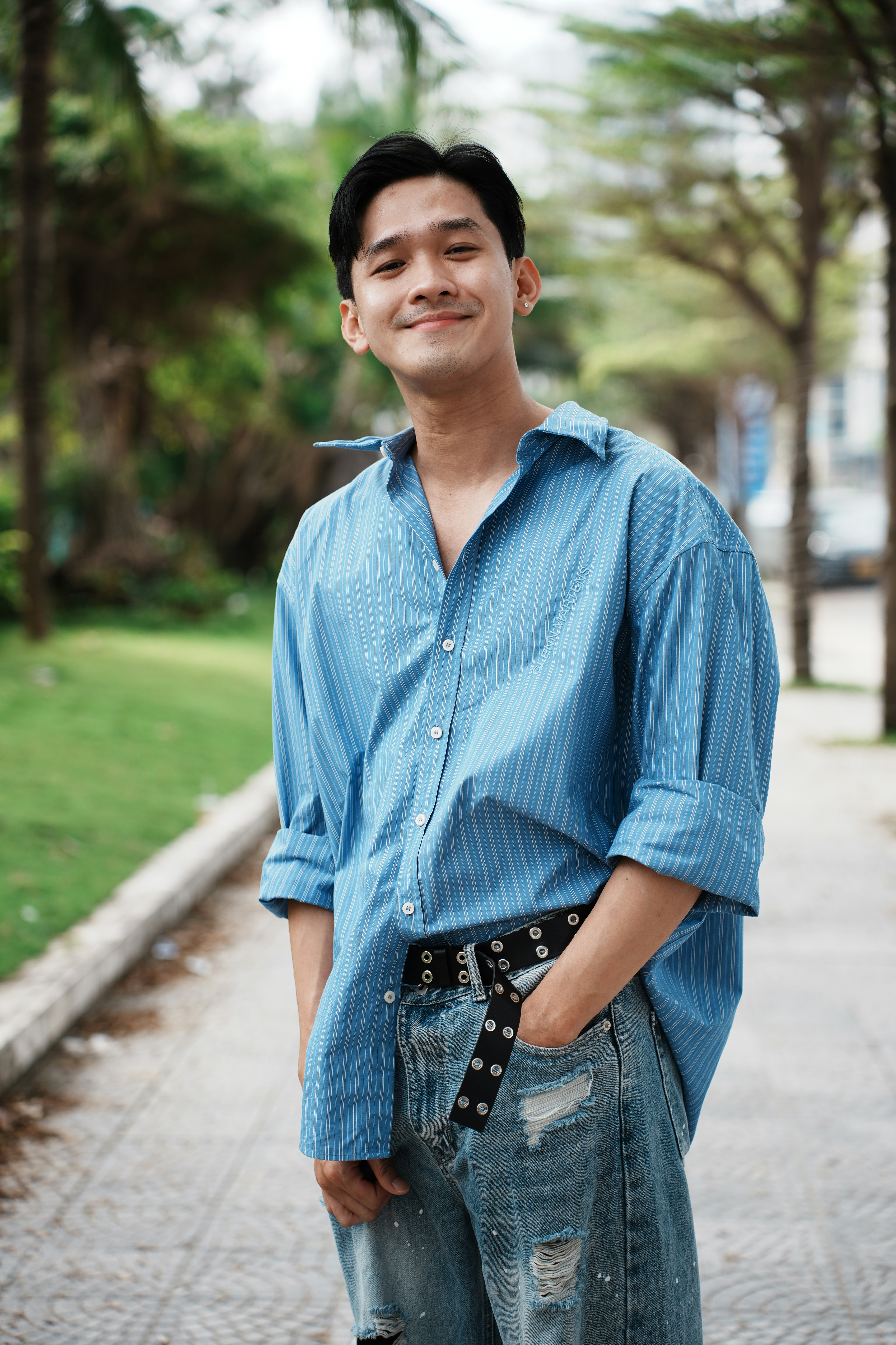 Casual Confidence: A Smiling Moment in a Blue-Striped Shirt