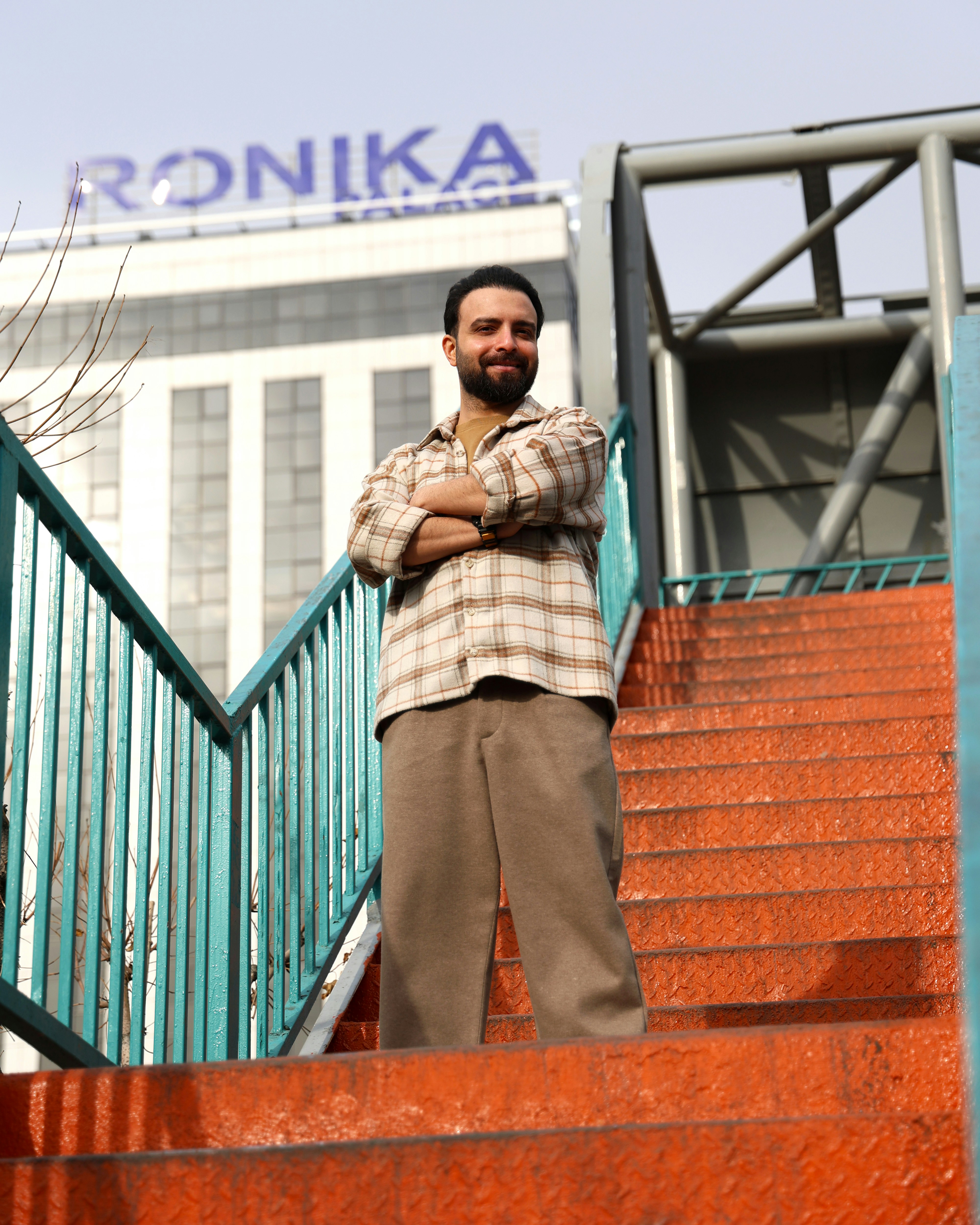Crossing Stairs: A Confident Portrait with Industrial Backdrop
