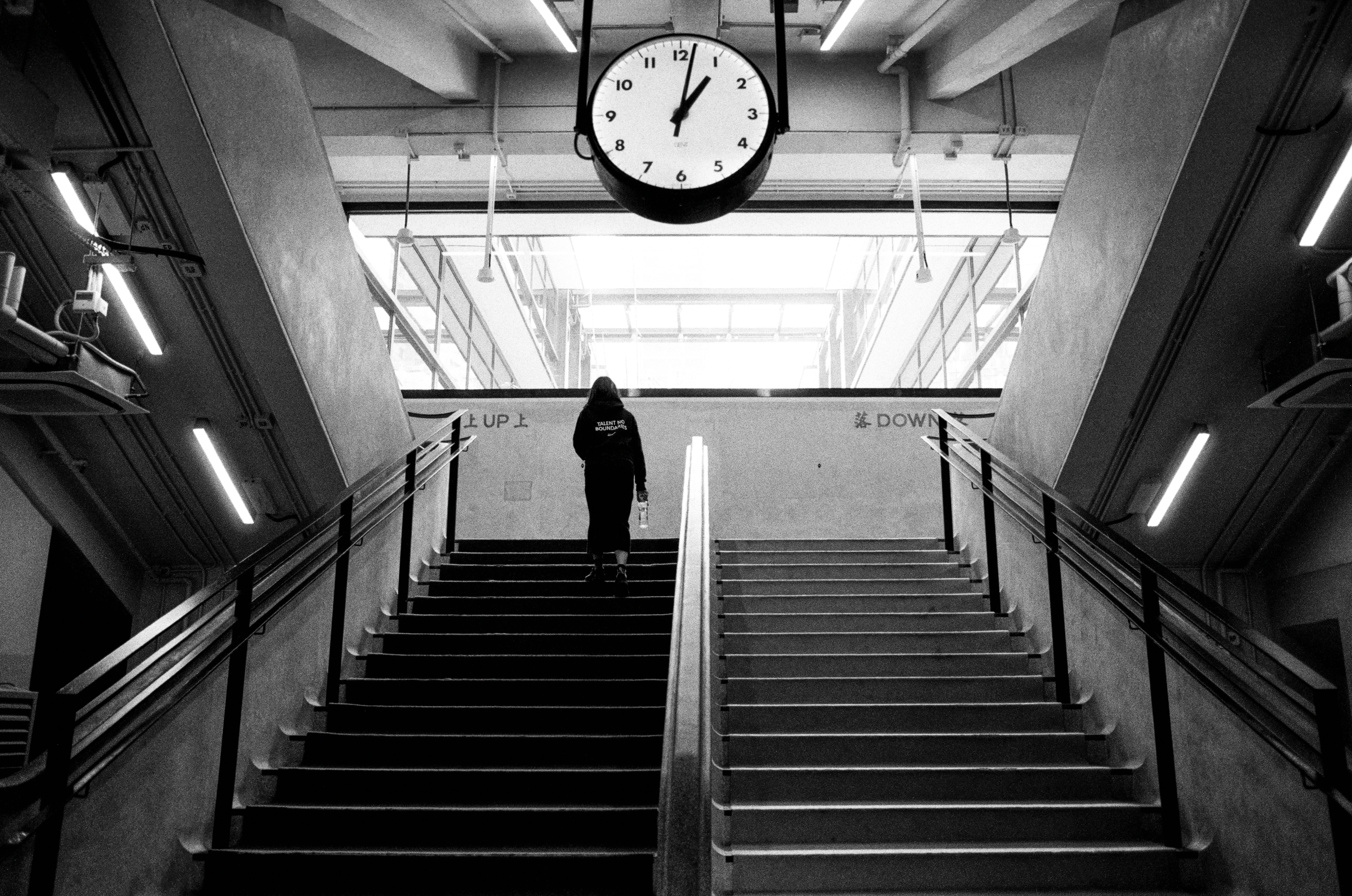 Person walks up stairs under large clock photo – Free Architecture ...