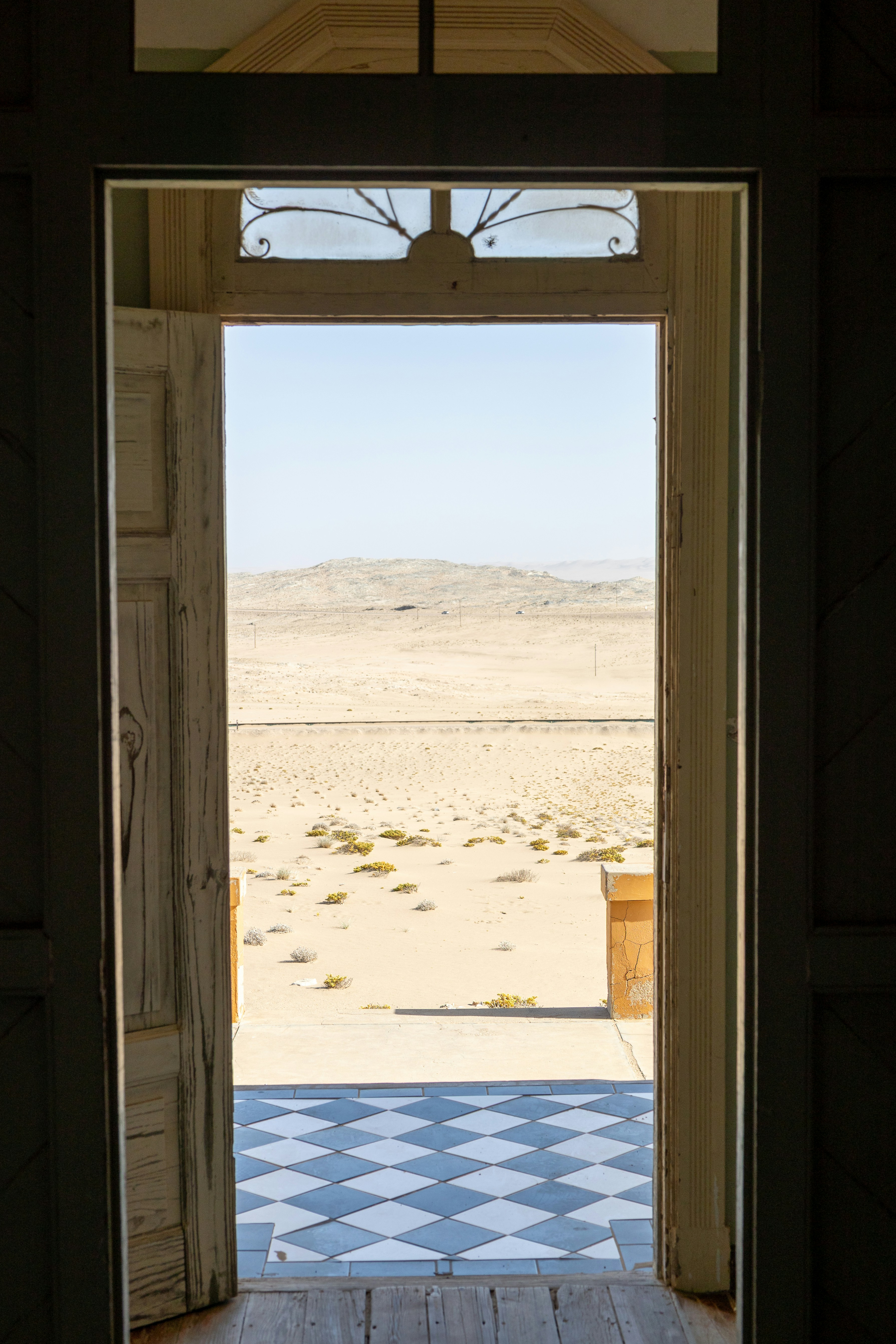 Desert Corridor: Framed Vista Through Weathered Doors