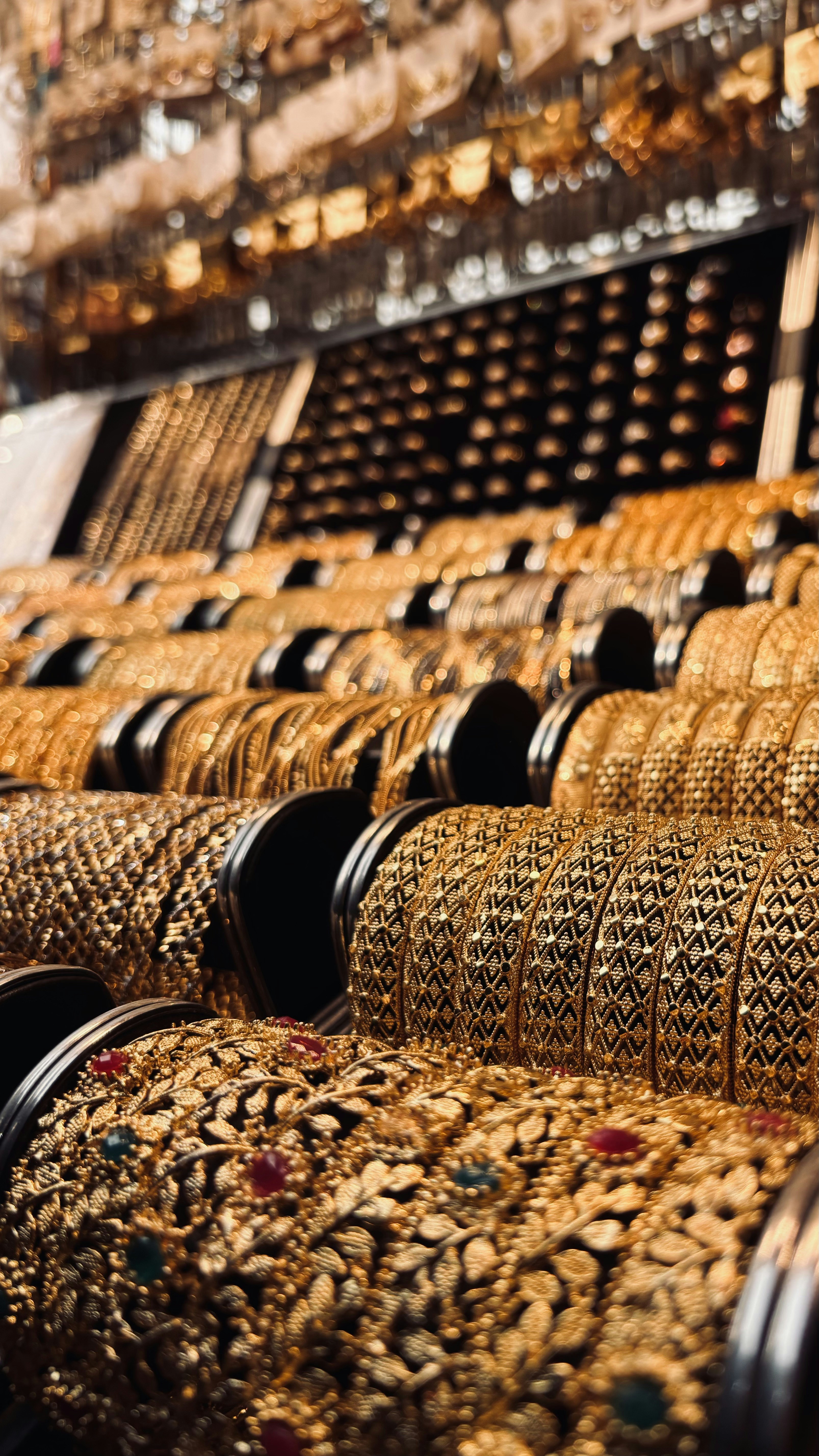 Golden Threads: A Rim of Beaded Bangles in a Velvet Display