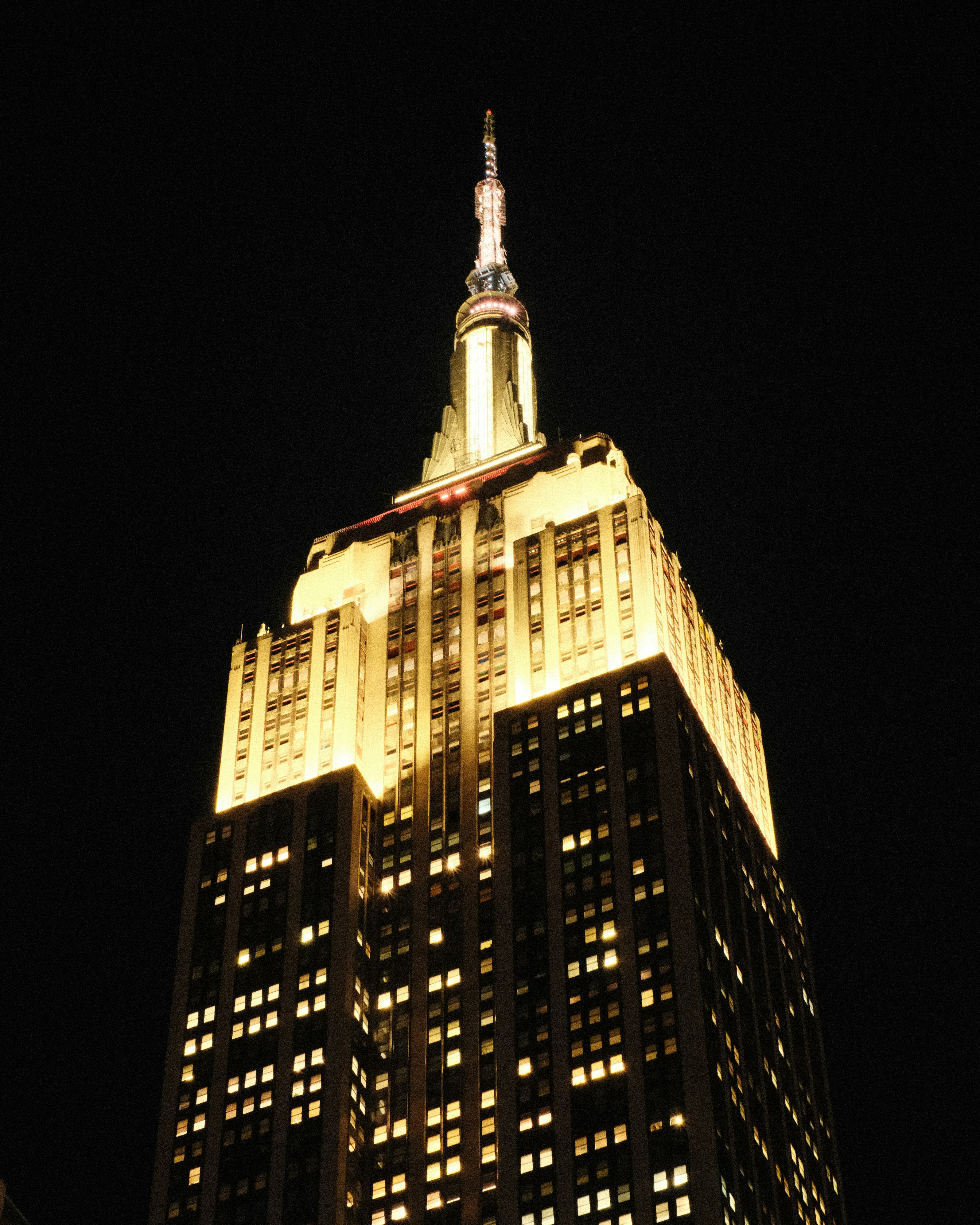 Golden Peak: Empire State-like Tower Silhouette in Night