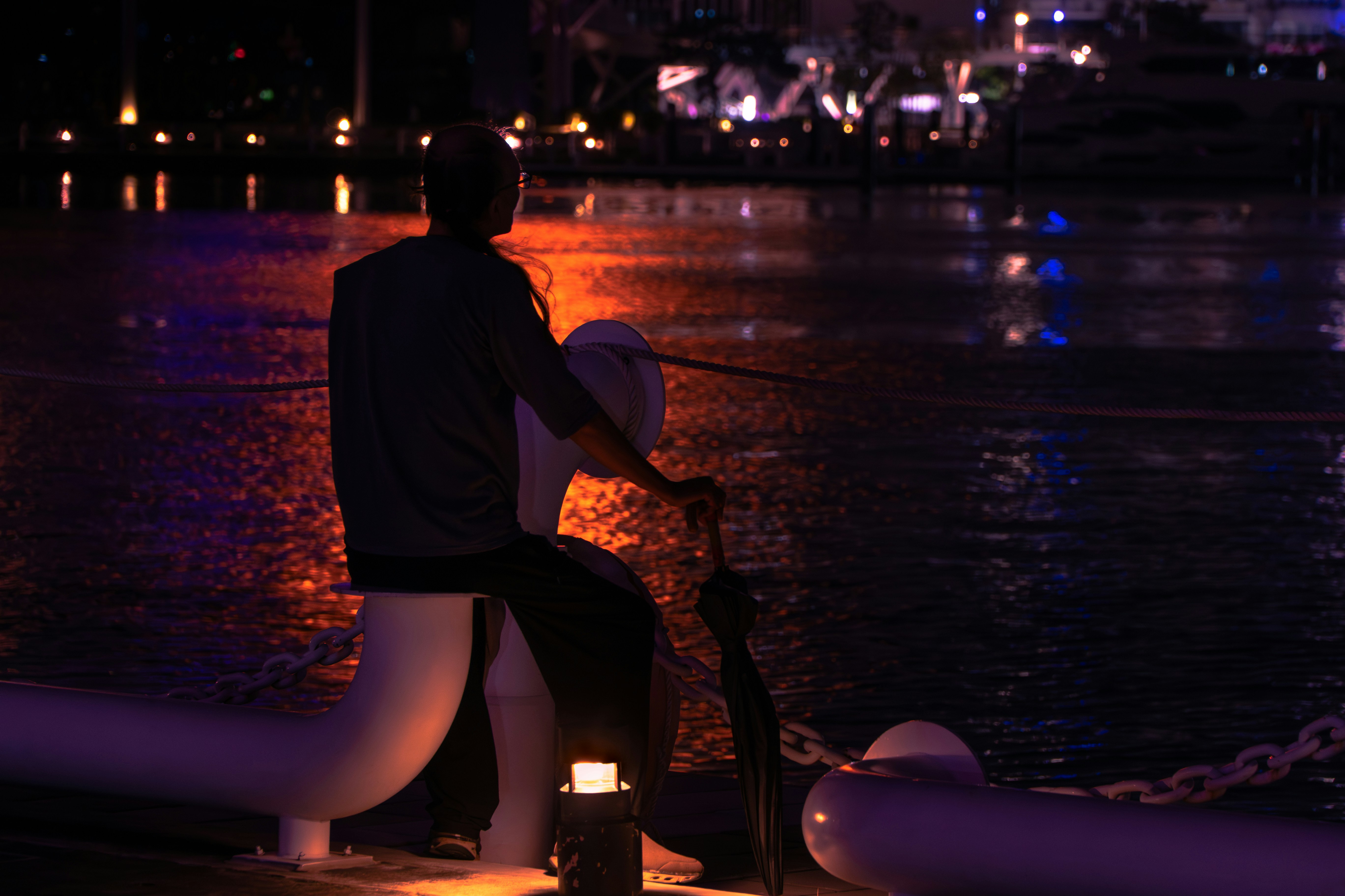 Nighttime Dockside Silhouette: A Quiet Conversation by the Water
