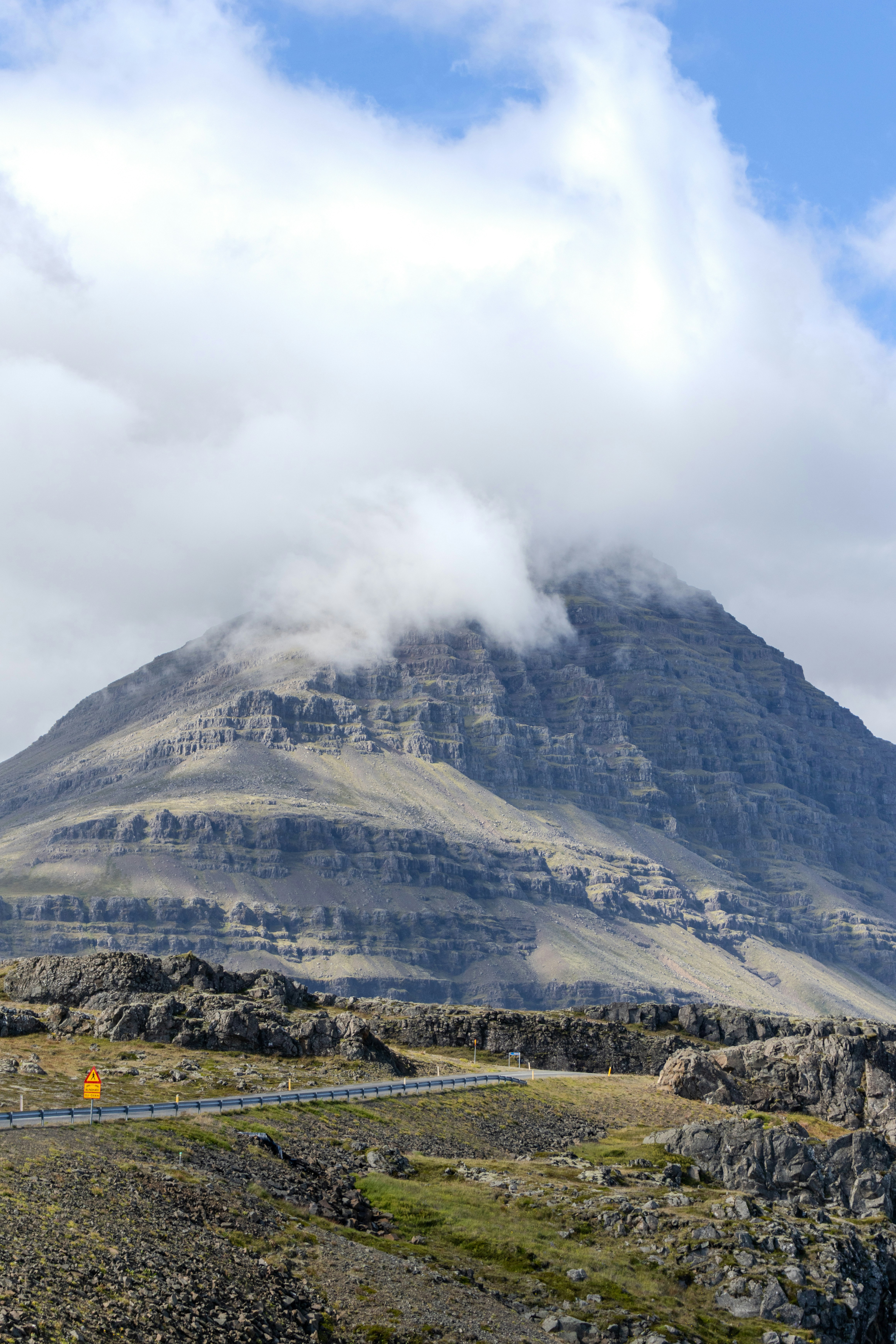 Clouds Cling to the Summit of a Rugged Volcano
