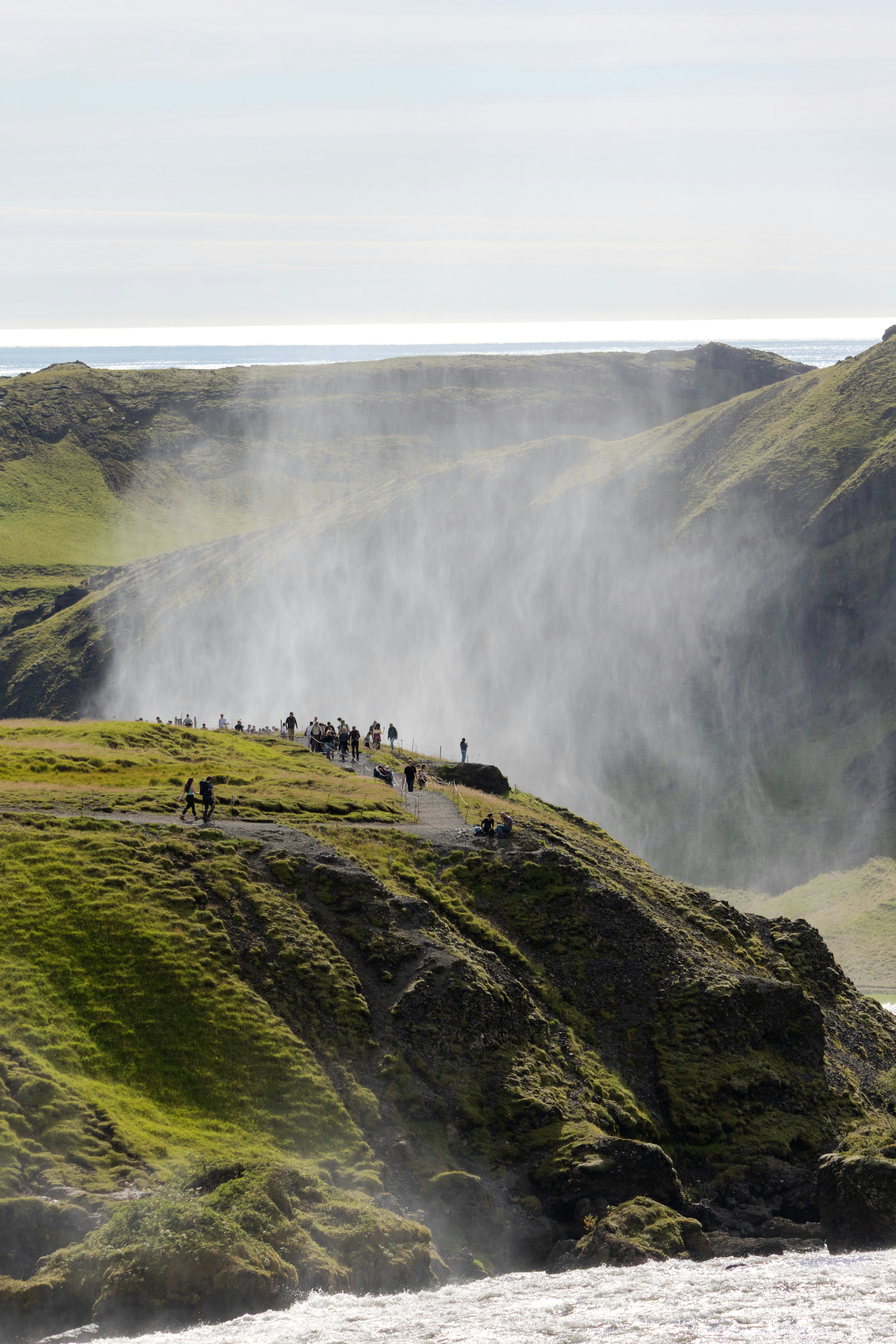 Cliffside Path Amid Mist: A Terraced Walk Above the Falls