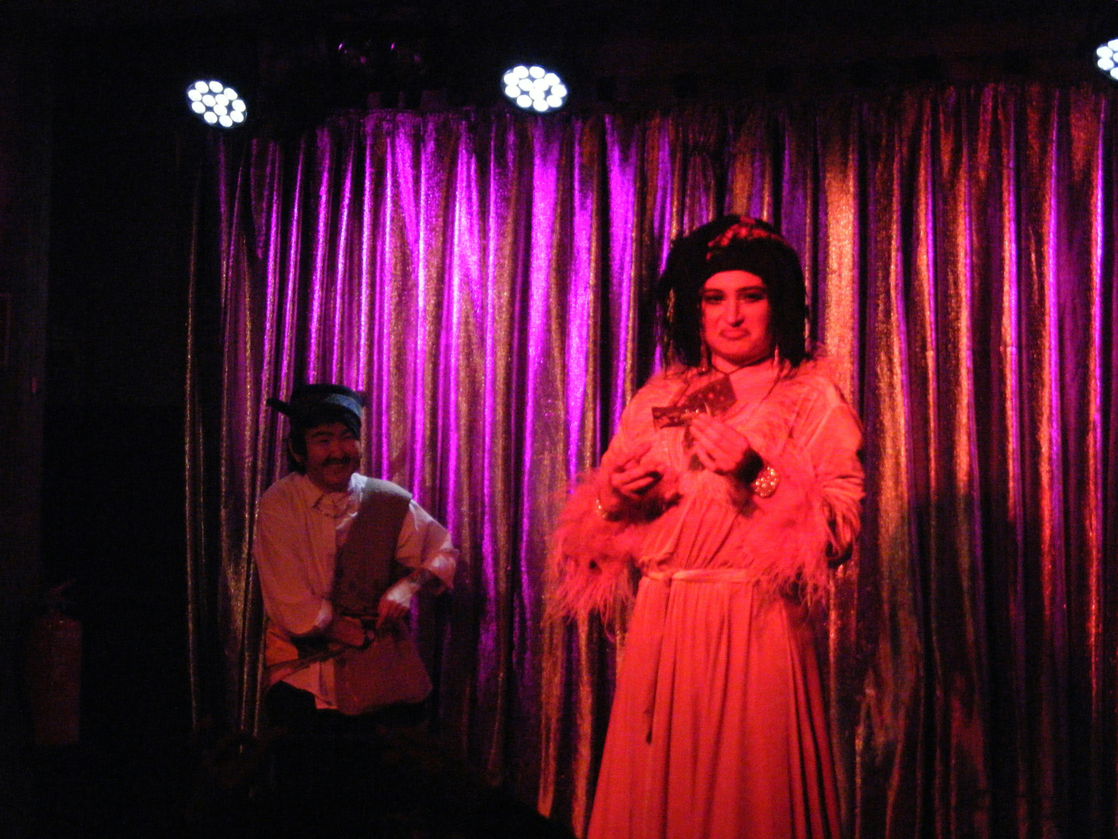 Drag performer in elaborate costume on stage