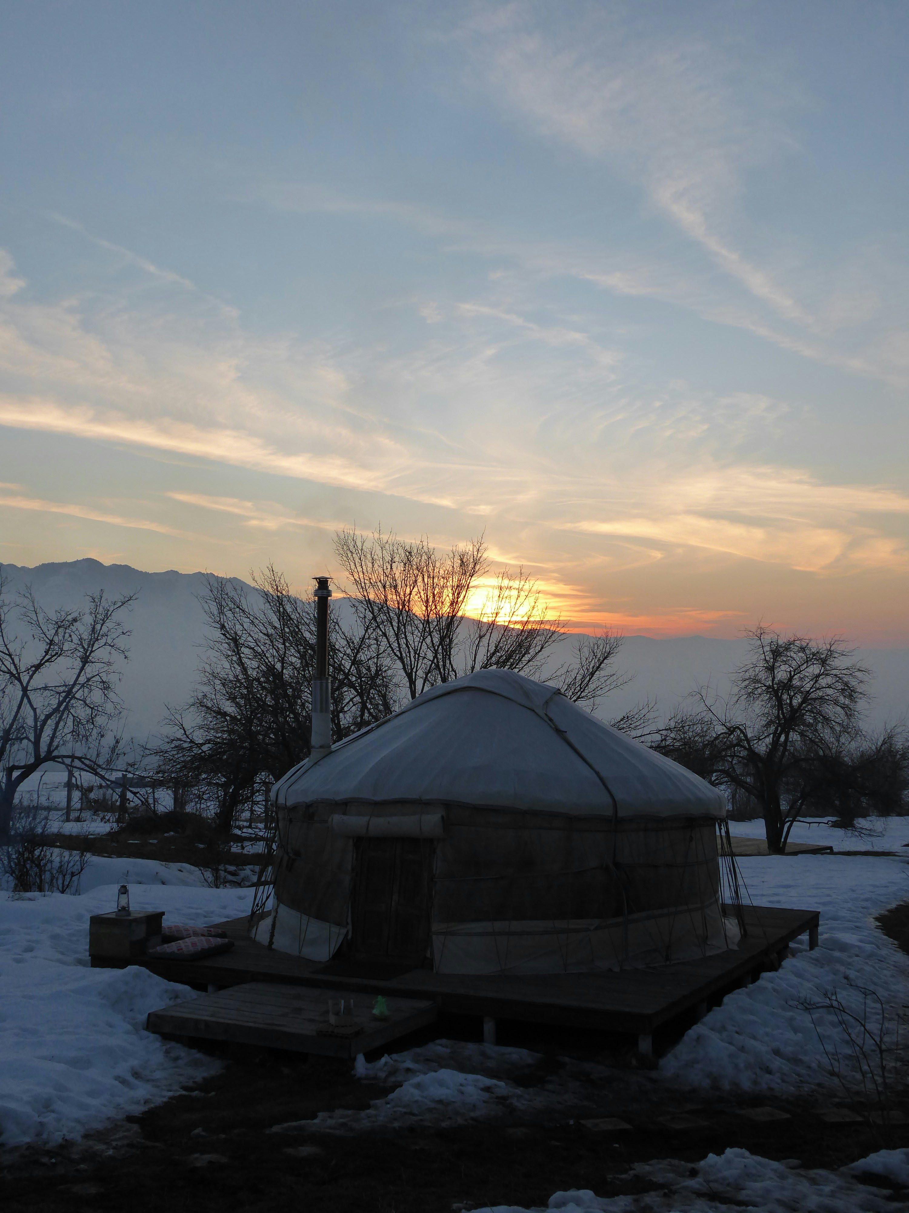 Yurt in a snowy landscape at sunset