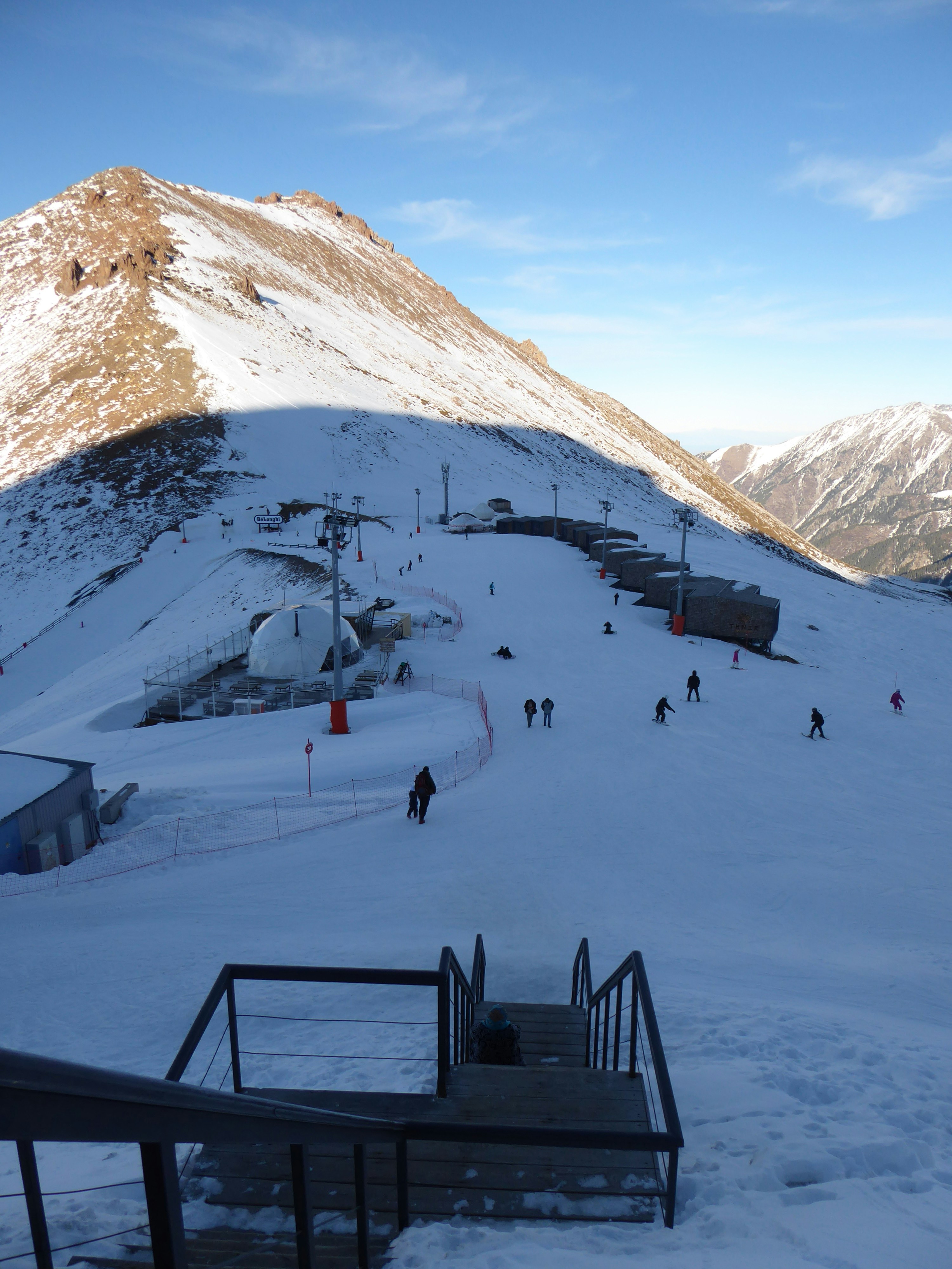 Ski resort with snow-covered mountains and skiers.