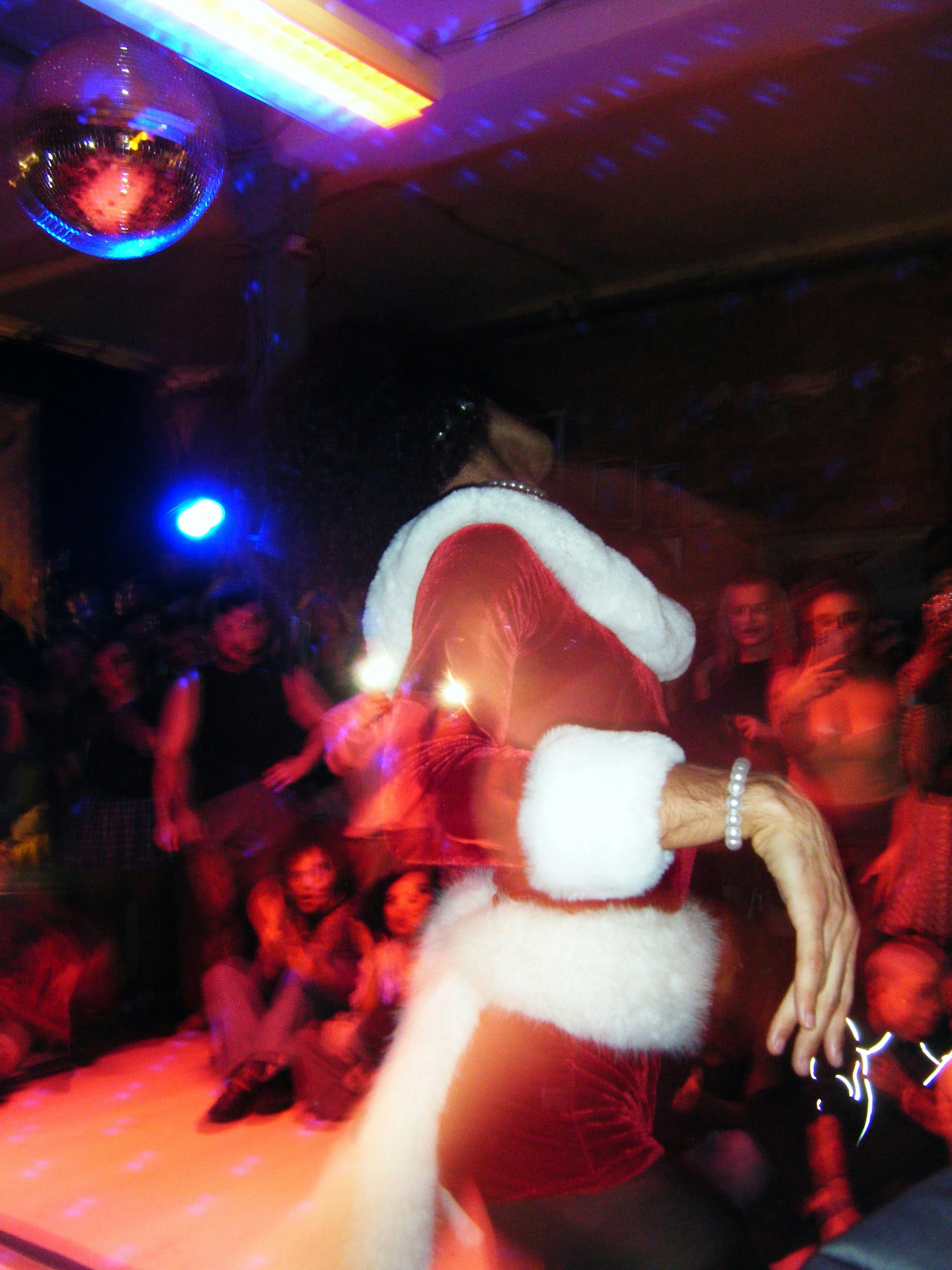 Person in santa costume dancing at a party