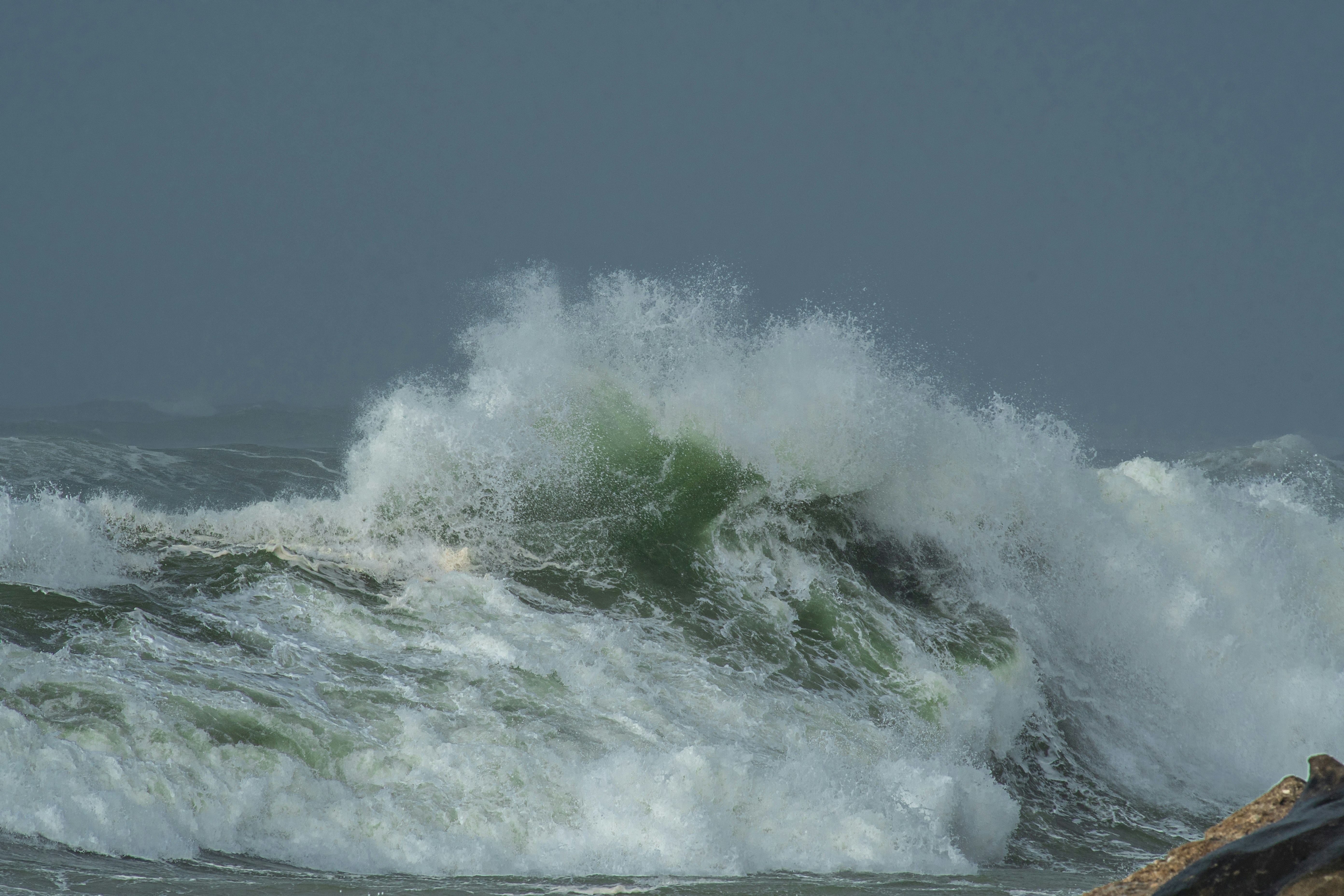 Cresting Breaker: Green Core Rising over White Foam