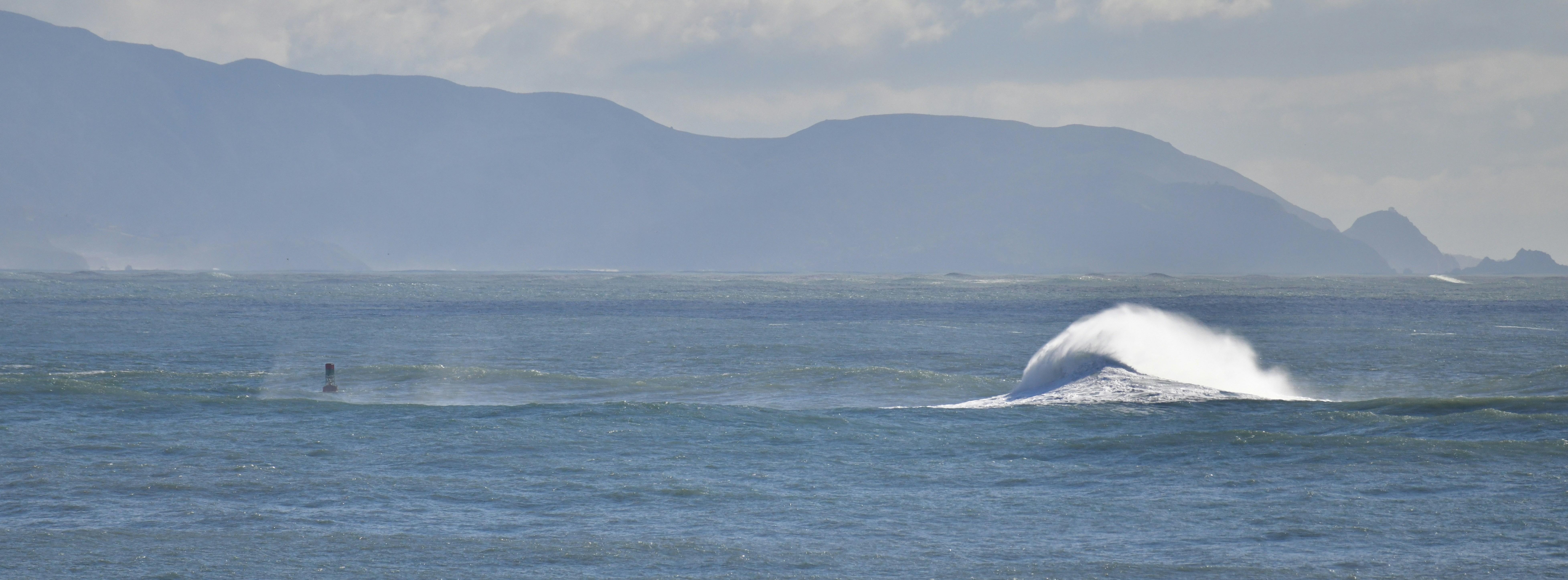Pacific Breach: A White Crest Emerges over the Blue Expanse