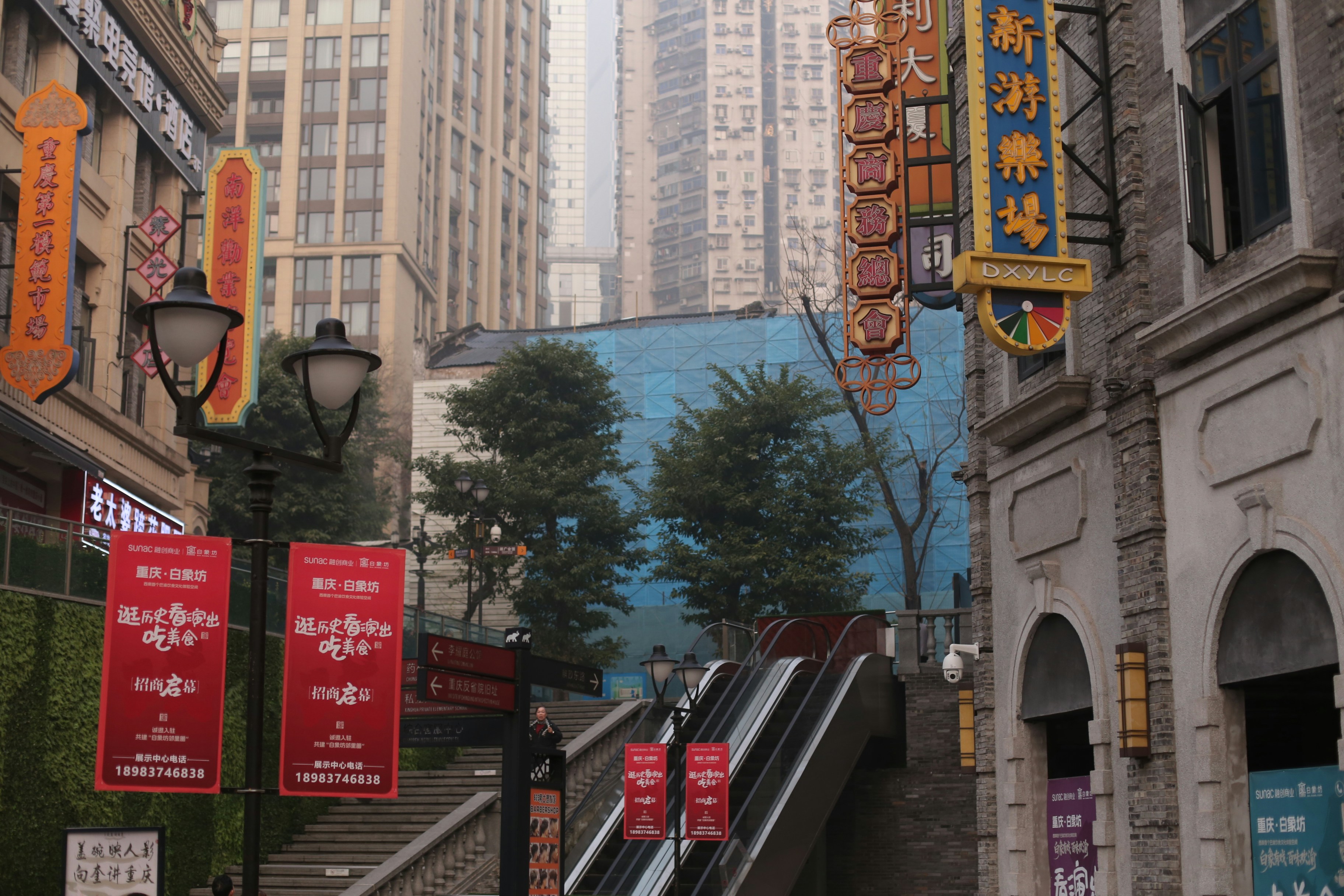 Urban Lanterns and Escalators: A City Passage Through Red Banners
