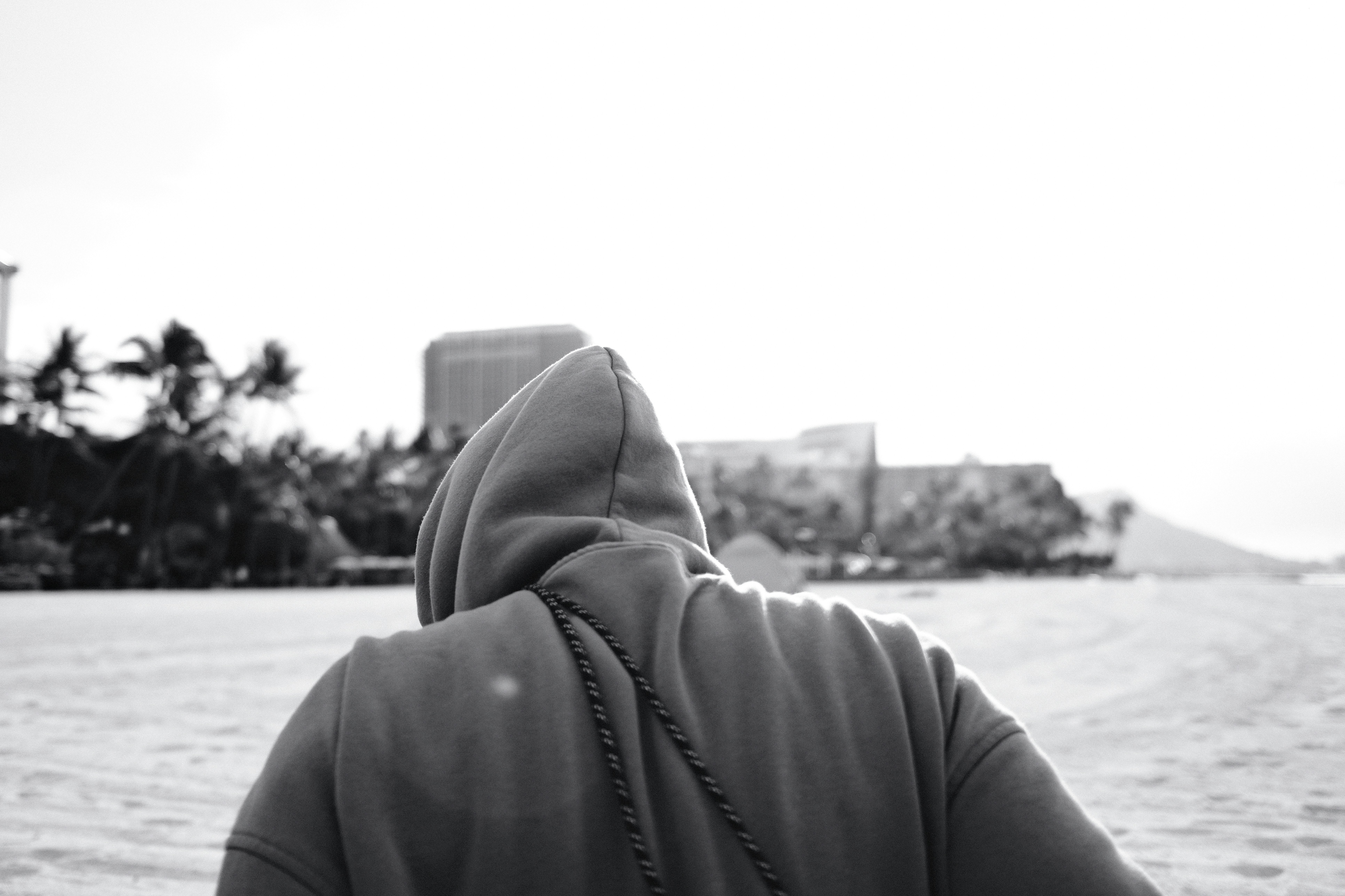 Horizon Hideaway: A Hooded Figure at the Beach