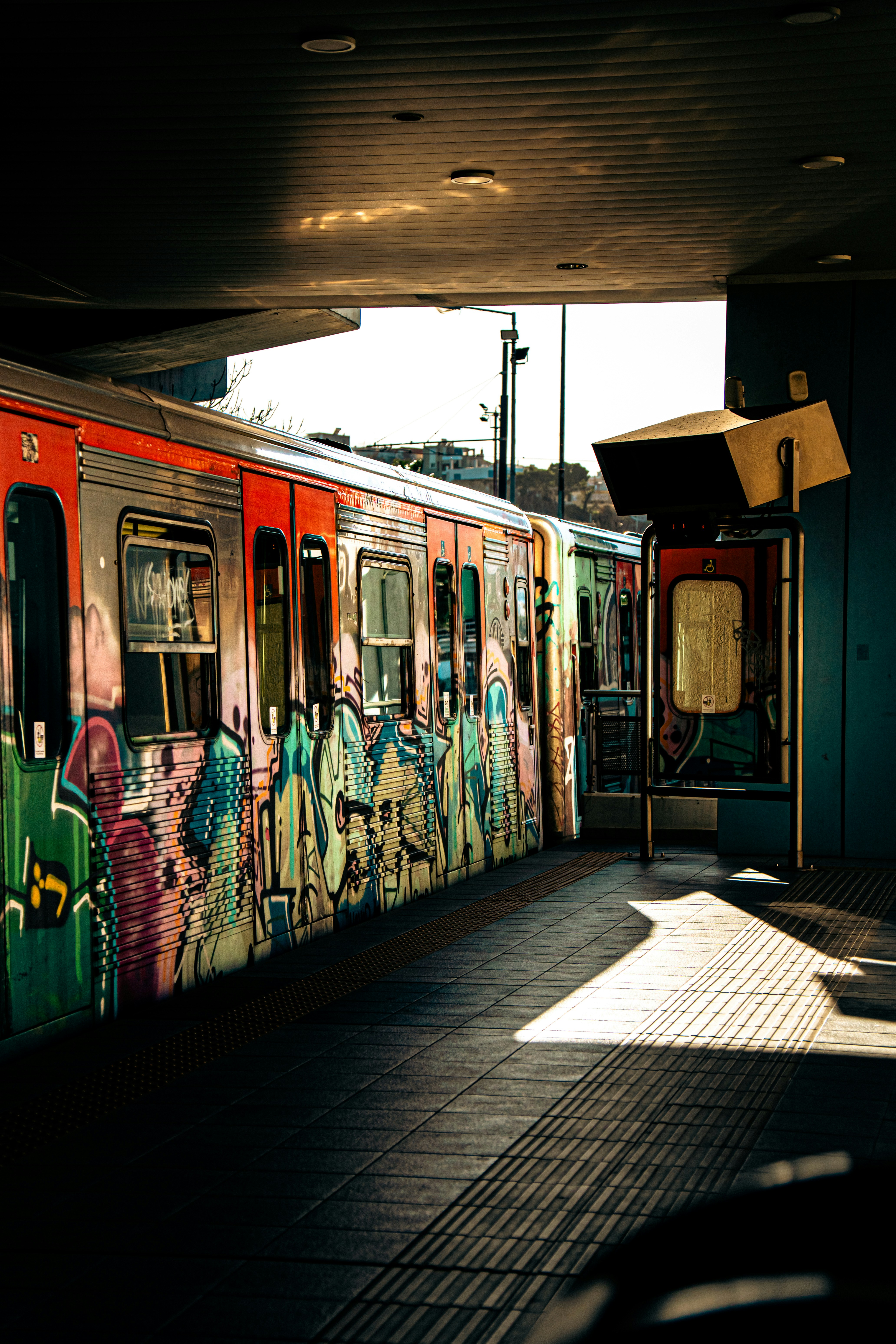 Graffitied Carriage in the Dim Platform Light