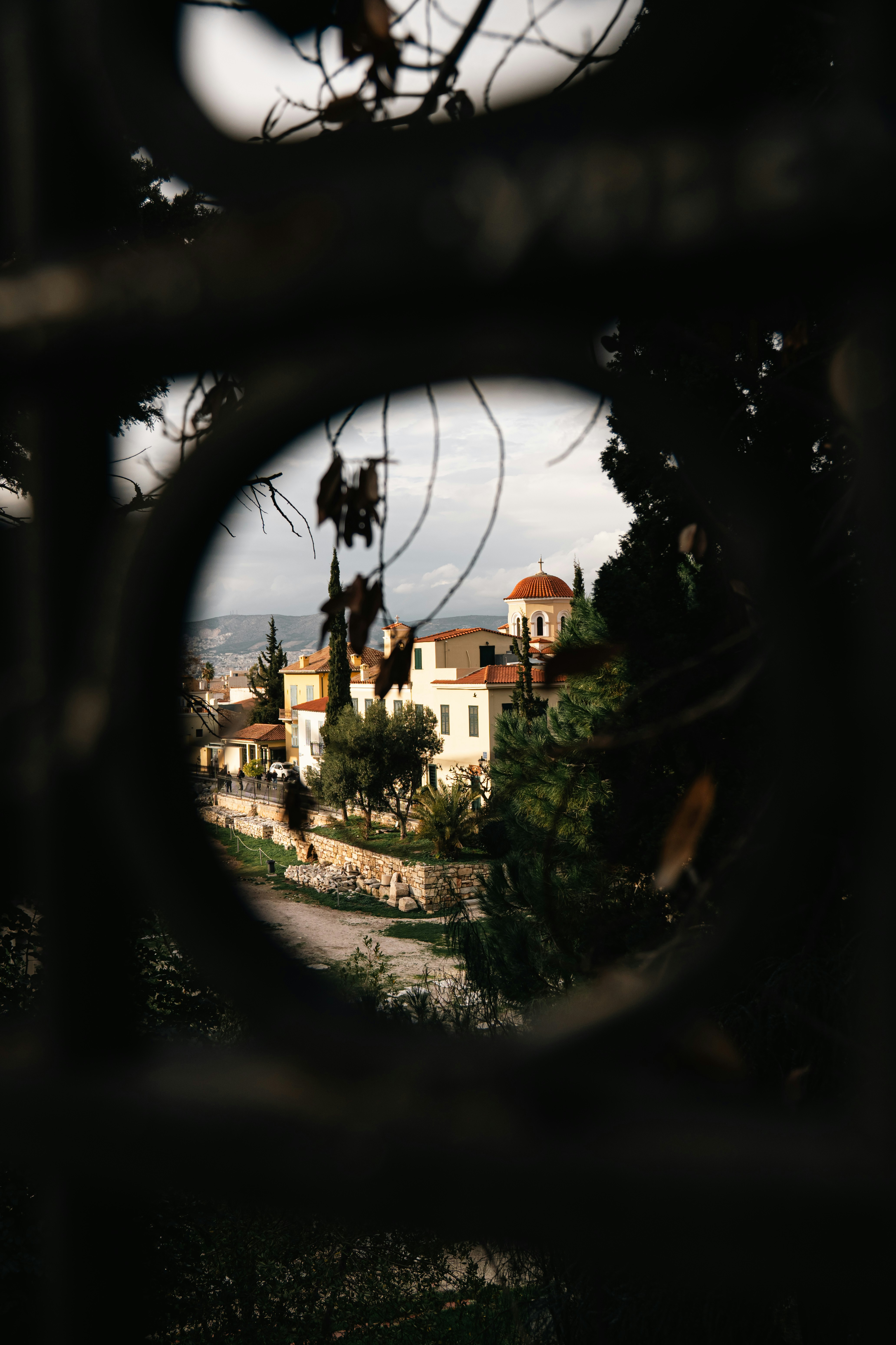 Through the Wrought Iron Frame: A Mediterranean Village Emerges in Focus