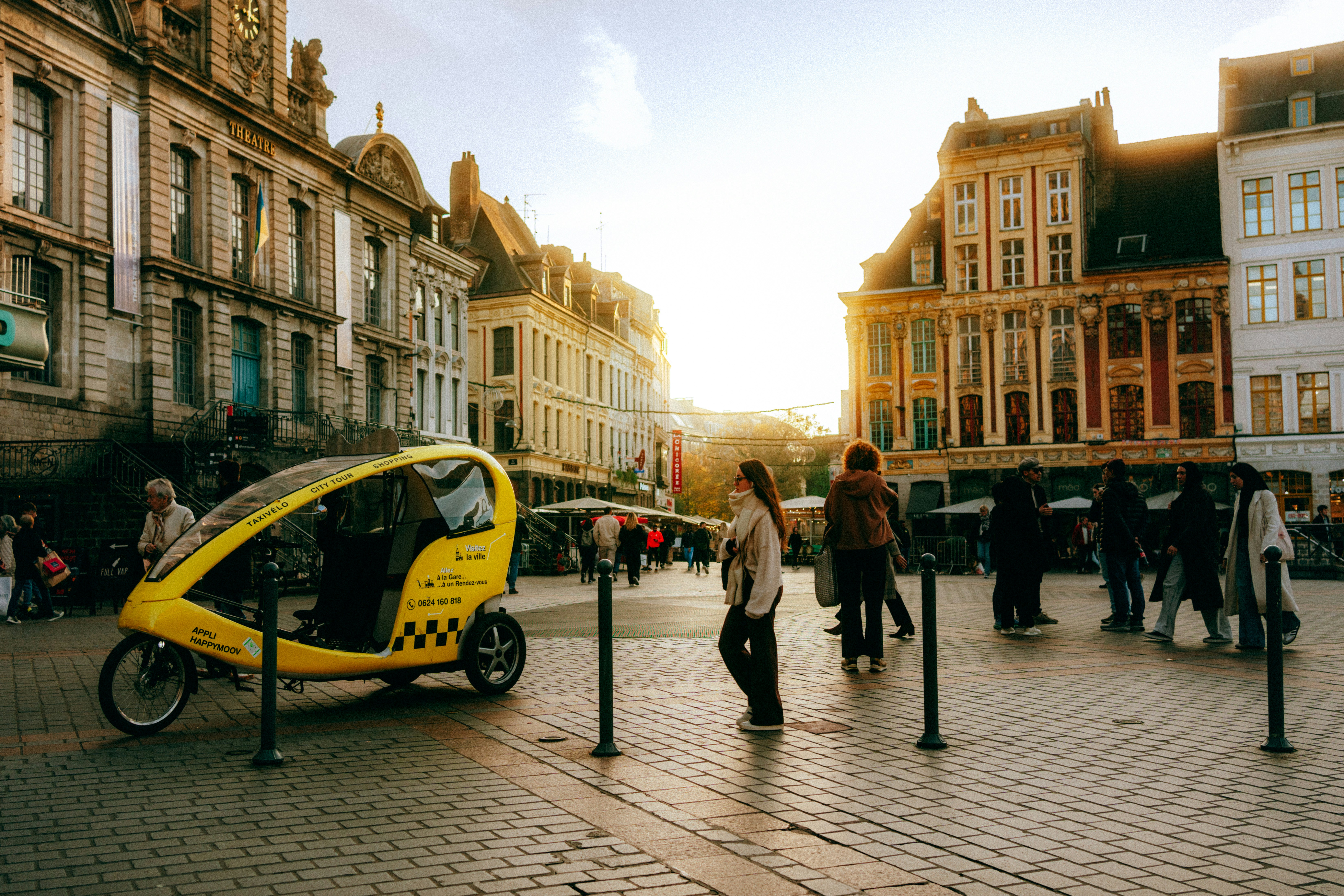 Sunlit Piazza Pulse: A Yellow Cab and Foot Traffic in a Historic European Square