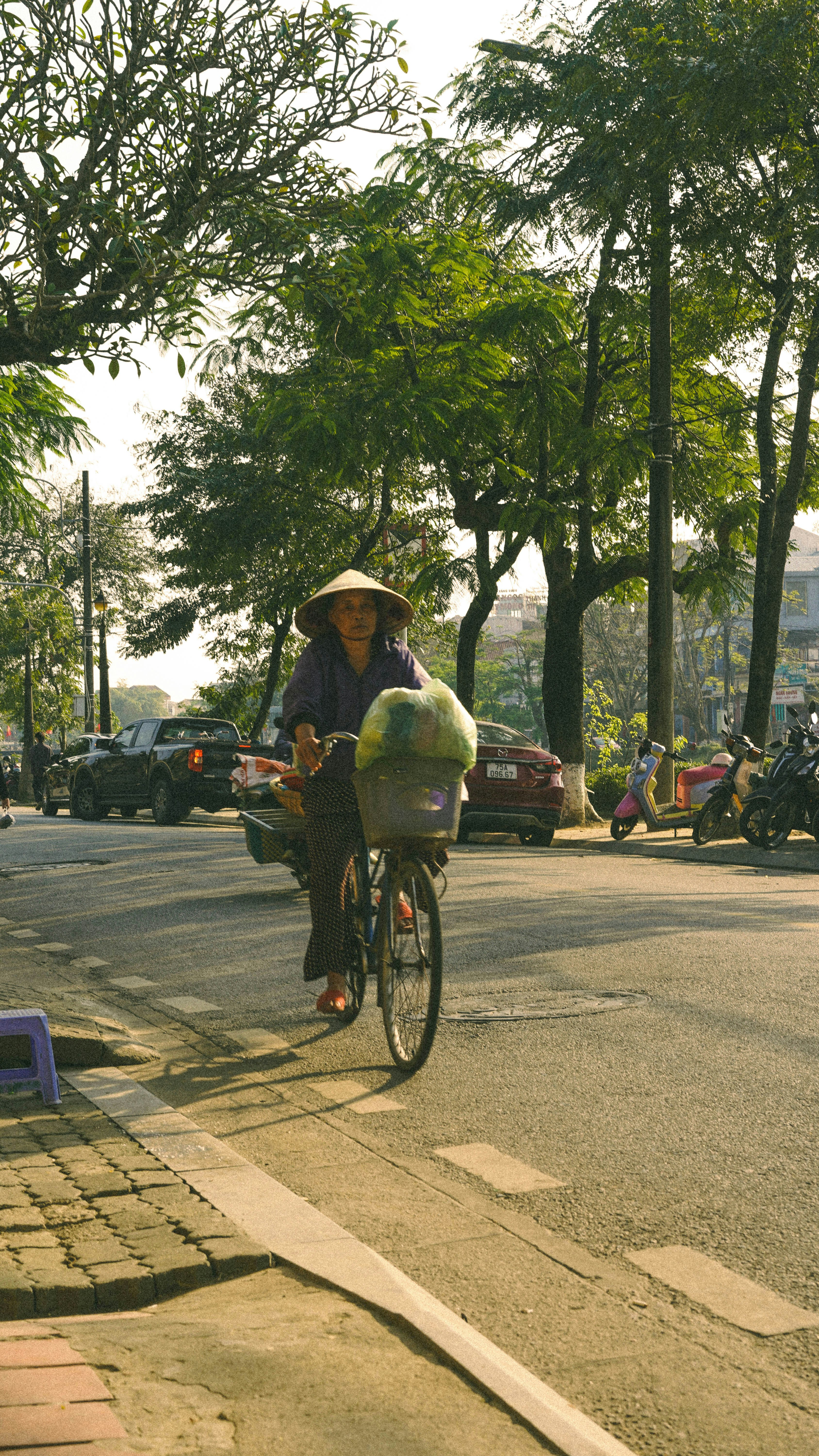 Rider in a Sunlit Street: A Quiet Moment on the Move