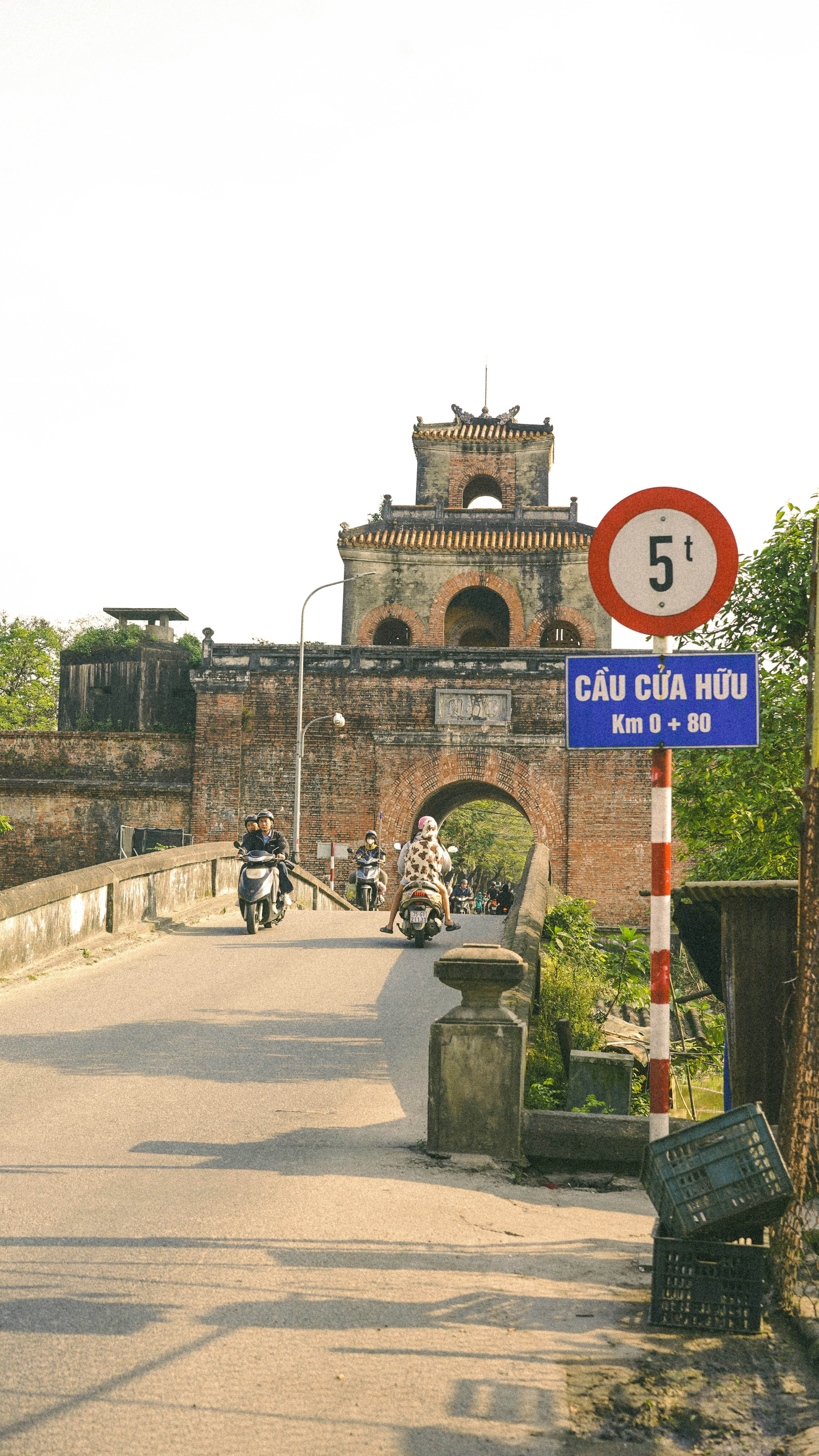 Gateway Through the Old Fortress: People Crossing the Bridge