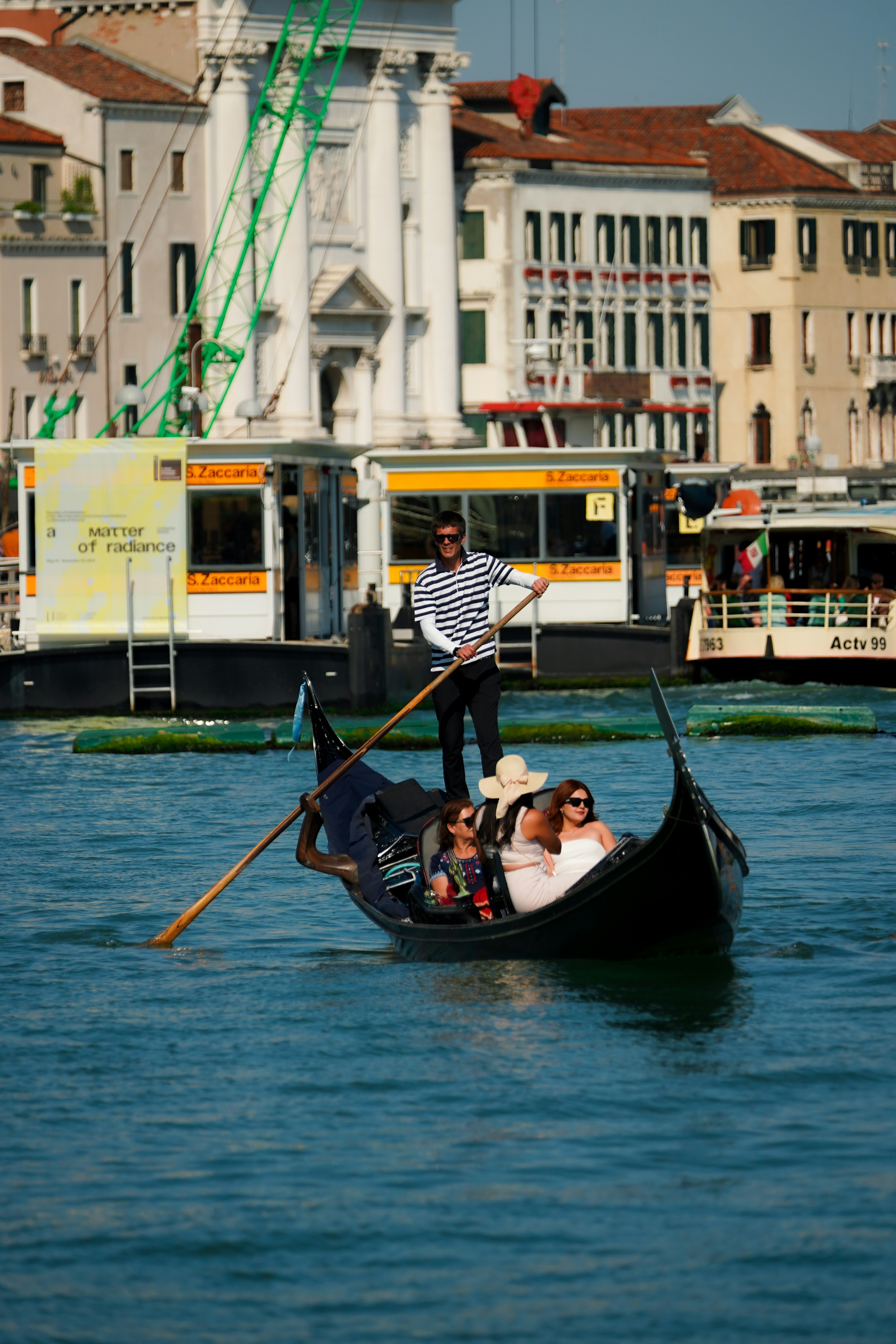 Gondola Parade: A Striped Sailor and a Lively Riverside Crew
