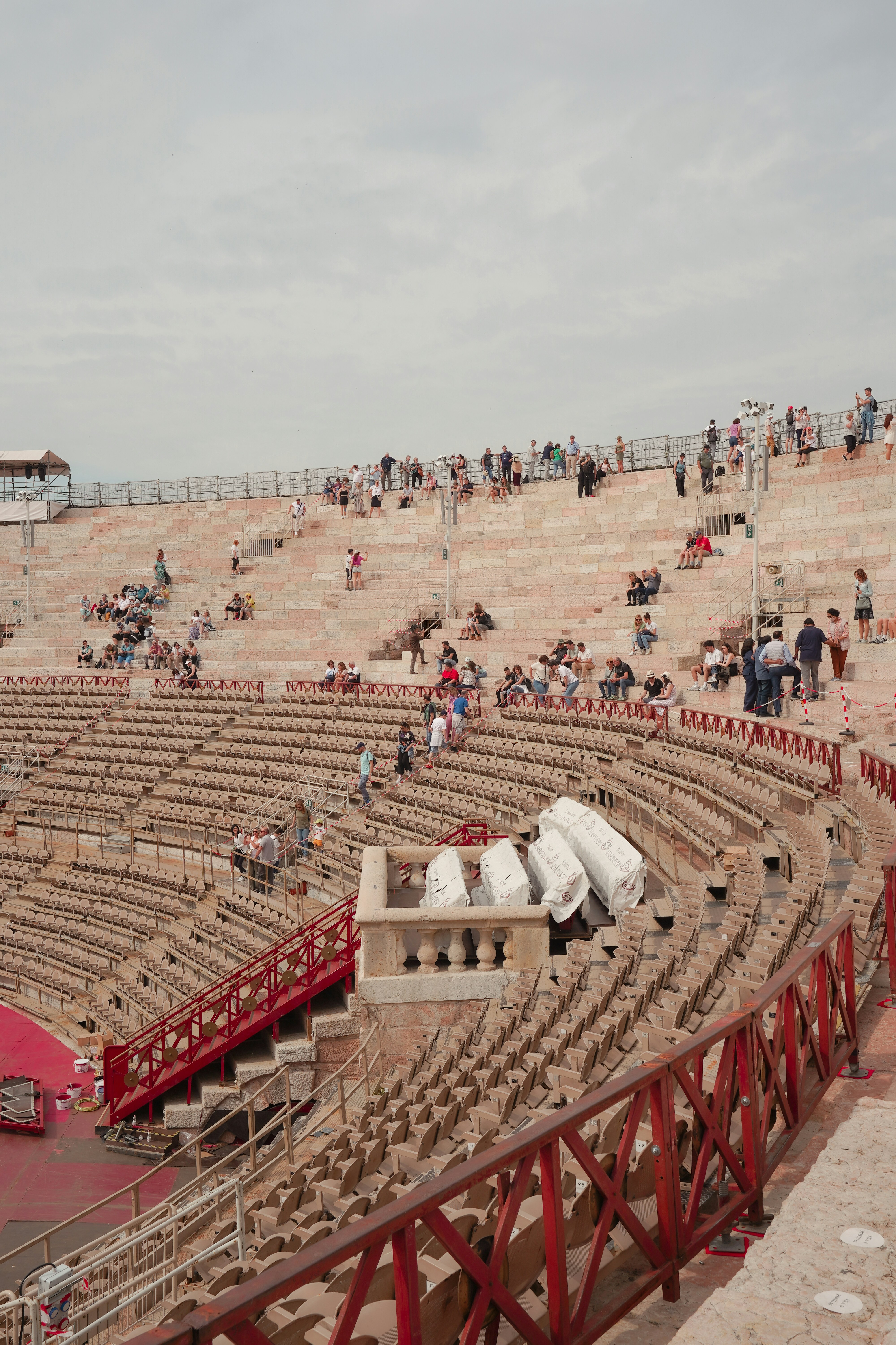 Red-Timbered Arena Terrace: Visitors Trekking the Ancient Amphitheater