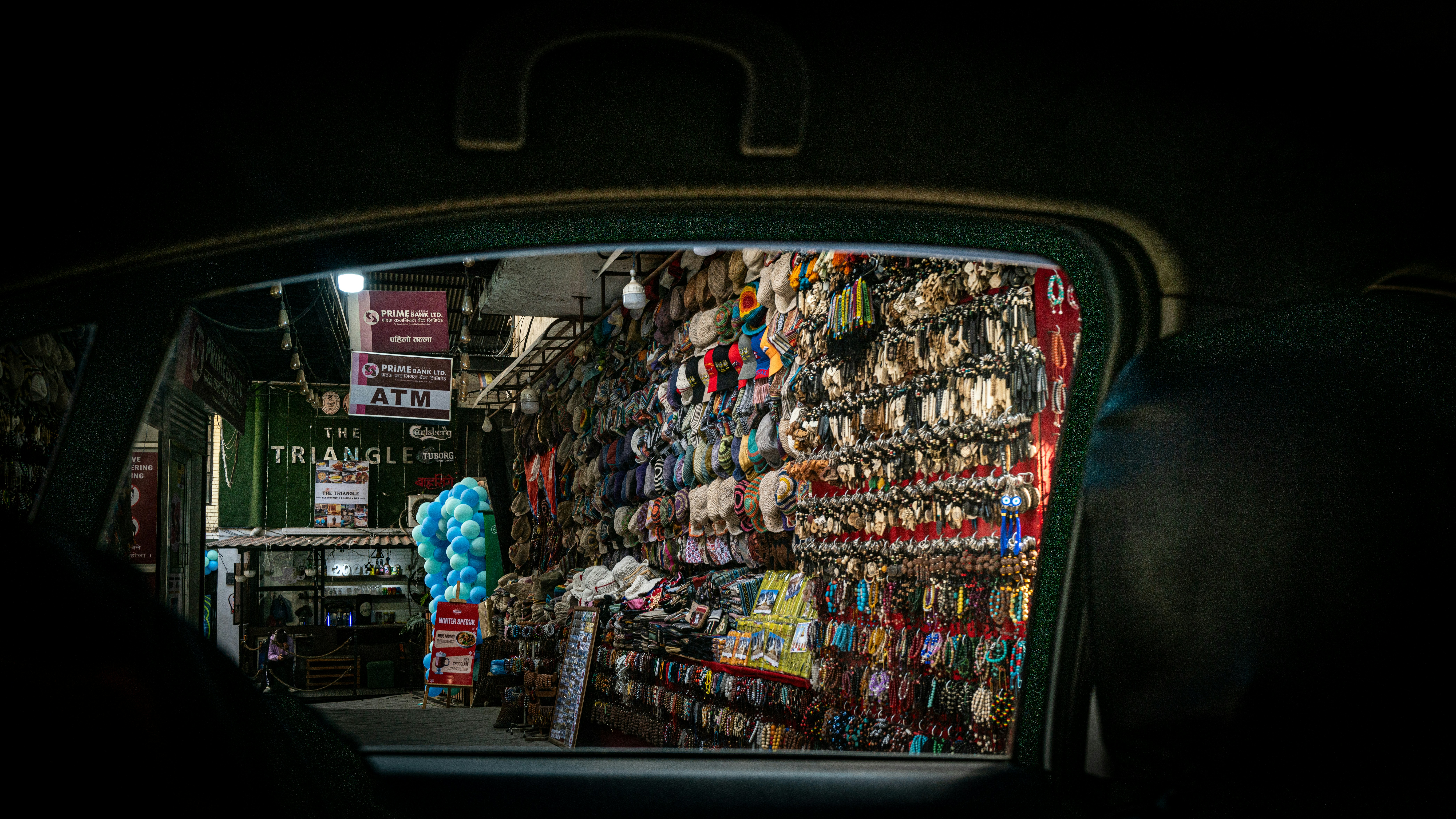 Colorful shopfront Corridor Through a Car Window