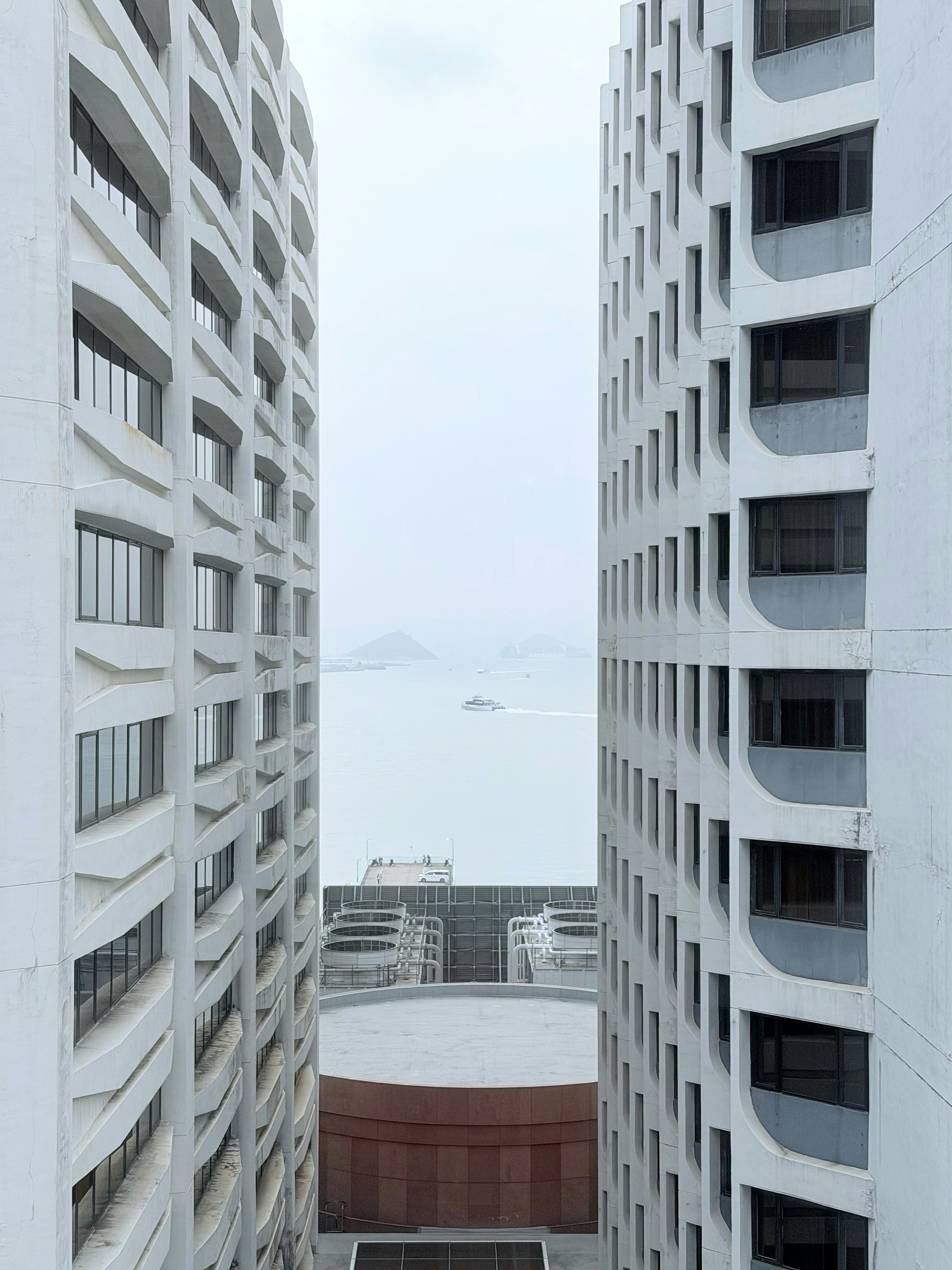 Between Two Towers: Sea Vista Framed by Concrete Narrowness
