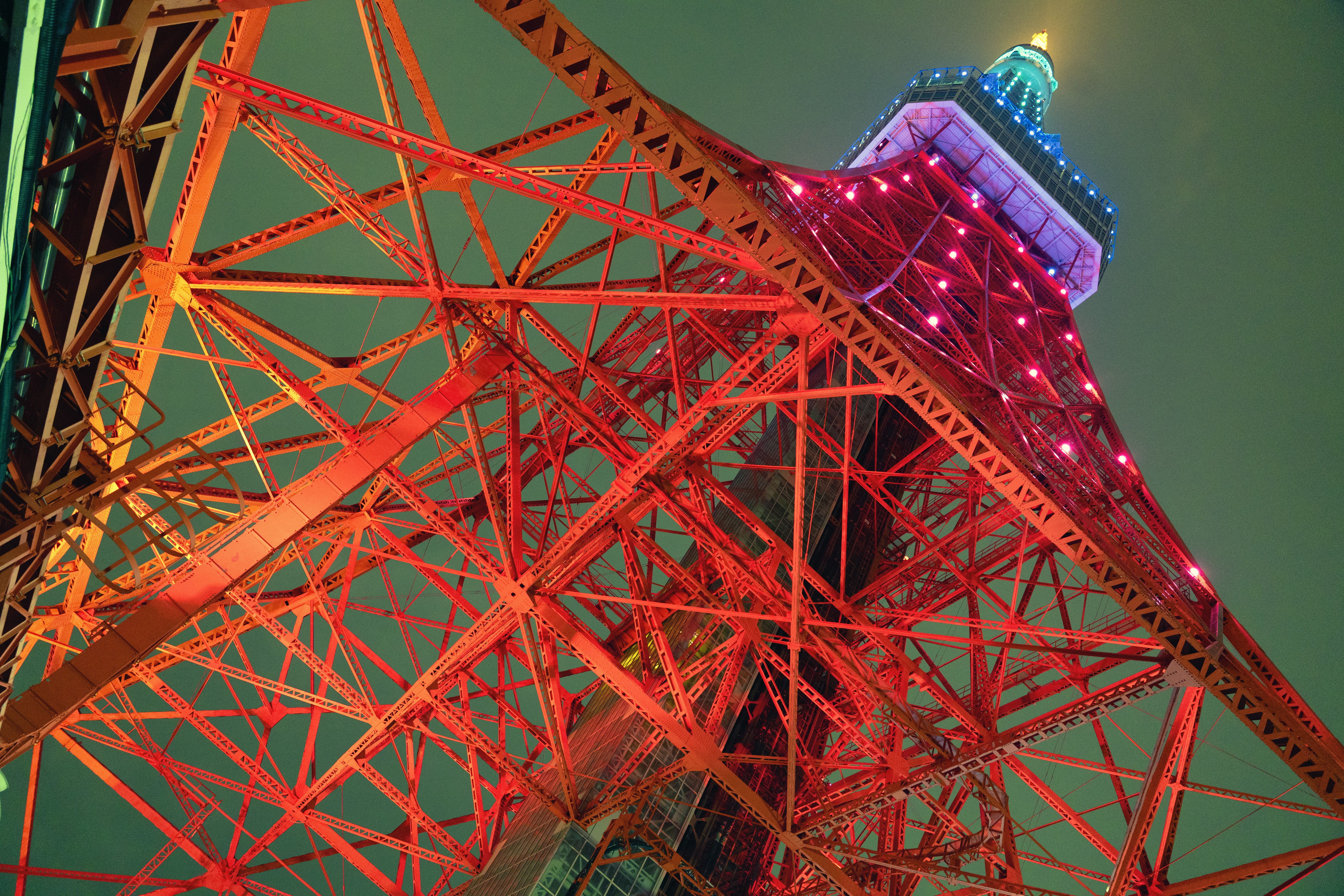 Crimson Steel Canopy: Neon Tower from Below