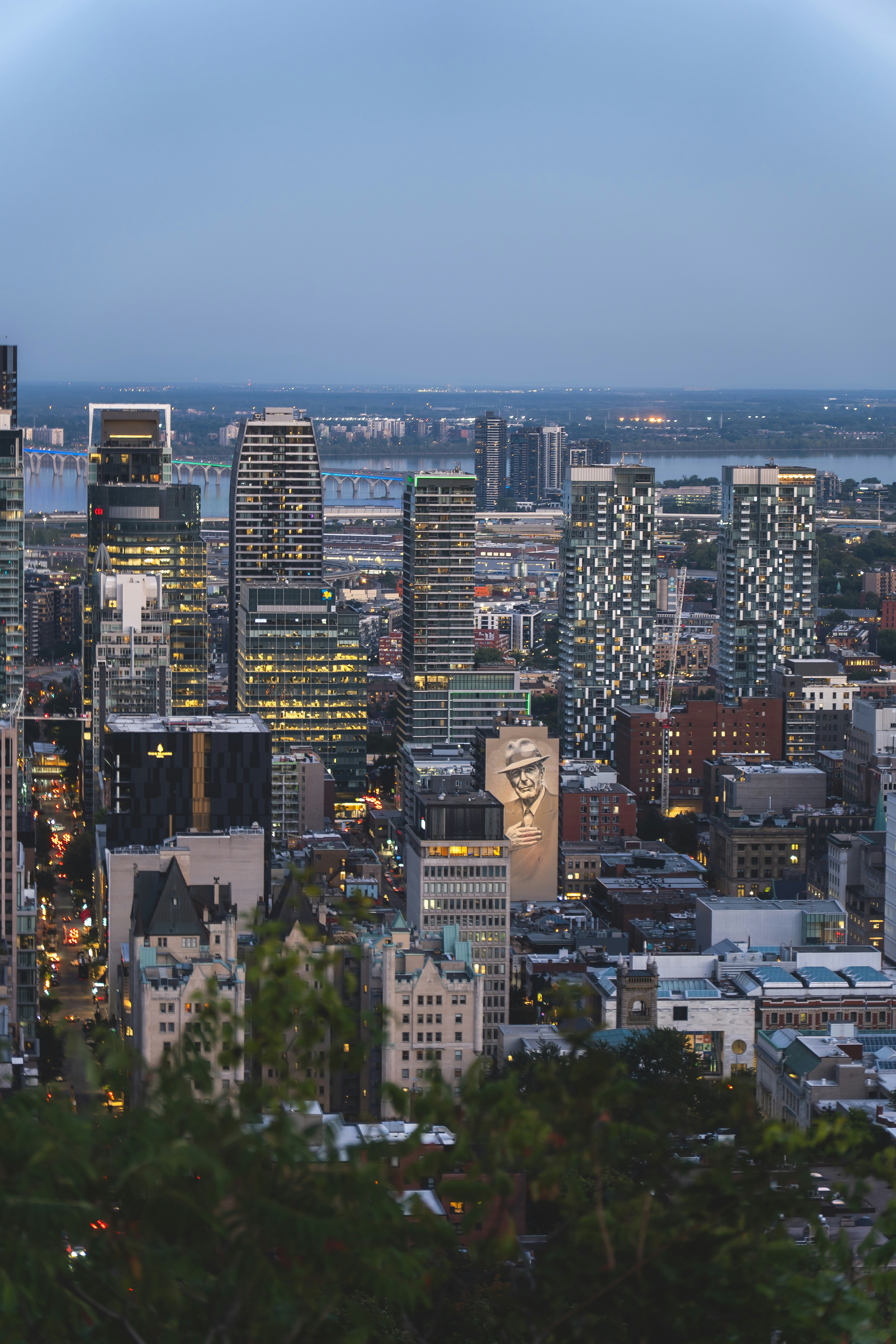 Urban Skyline at Dusk: Glass Towers Illuminated Amid Quiet Rivers