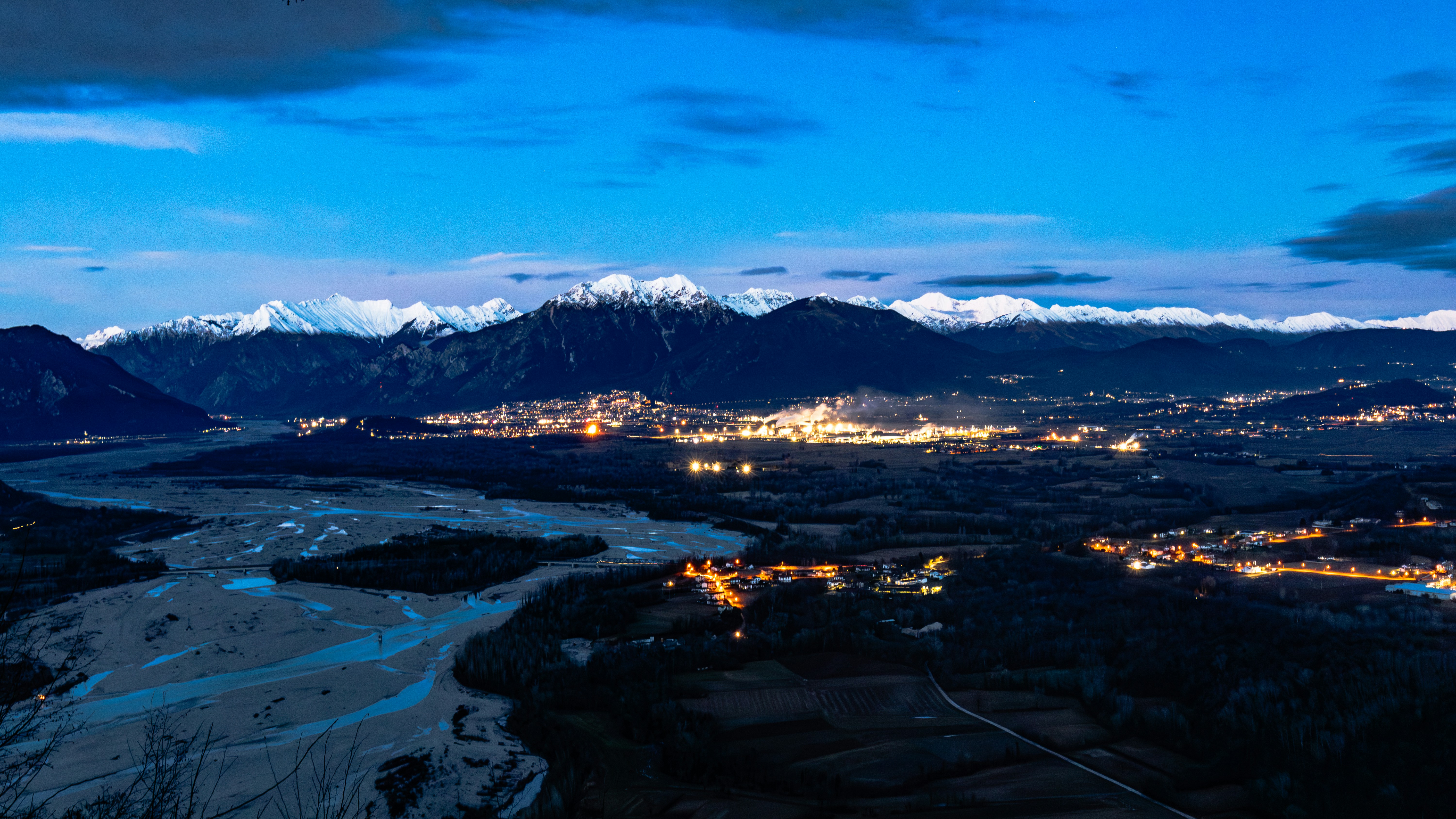 Twin-Set Distant Lights Over Snow-Capped Ranges at Blue Hour