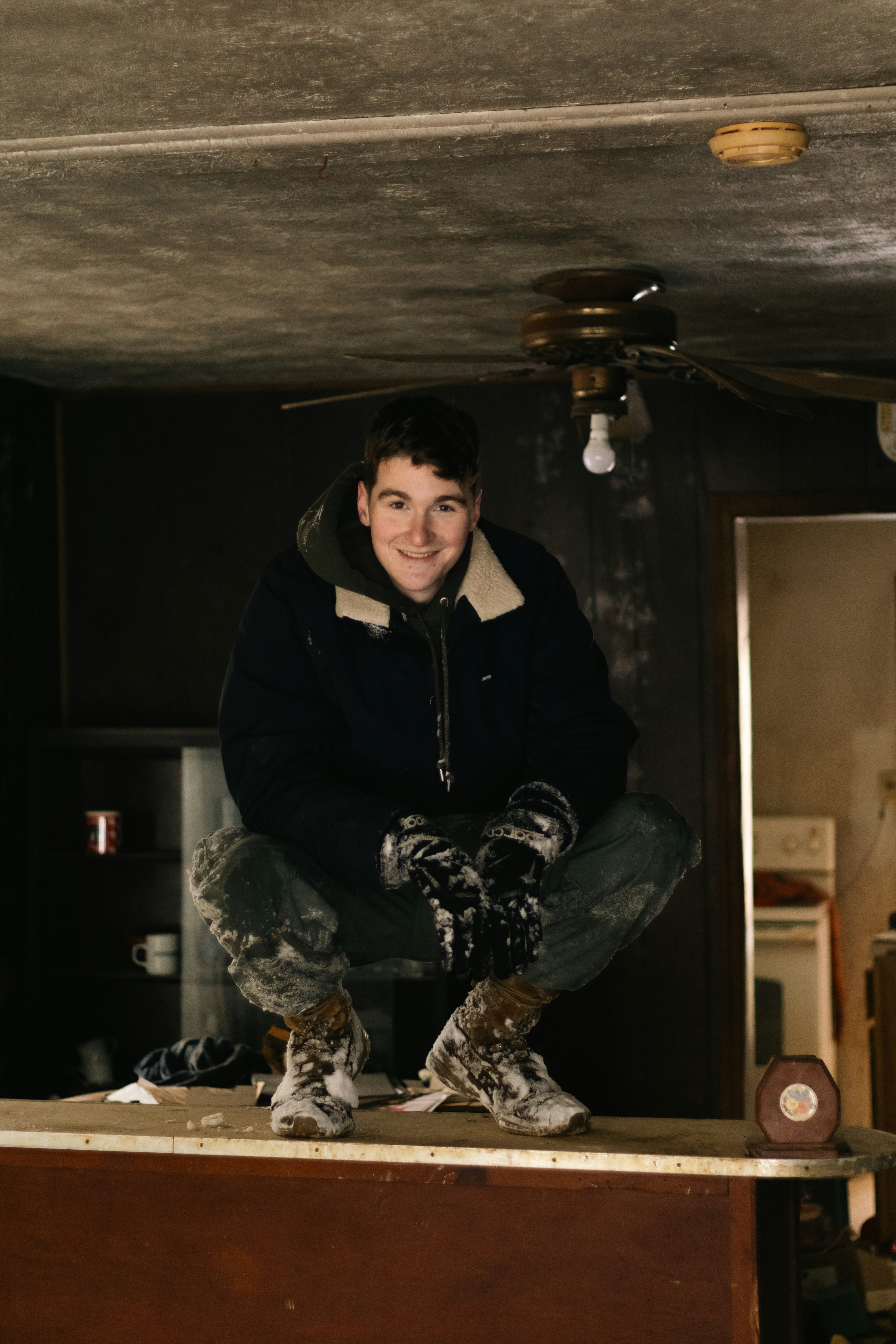 Youthful Builder on a Projected Plank Platform in Dim Workshop