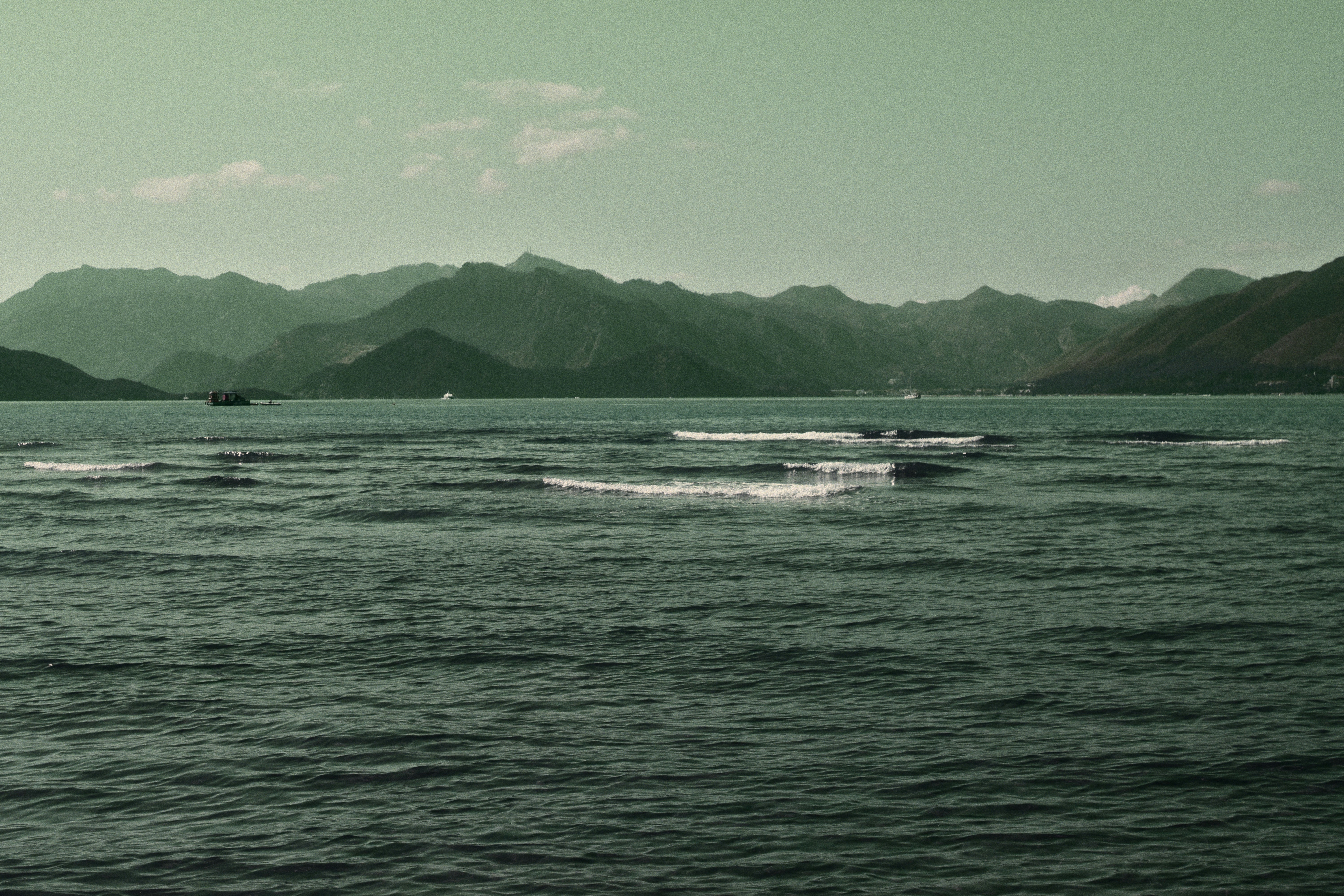 Quiet Seascape: Distant Mountains Guard the Horizon
