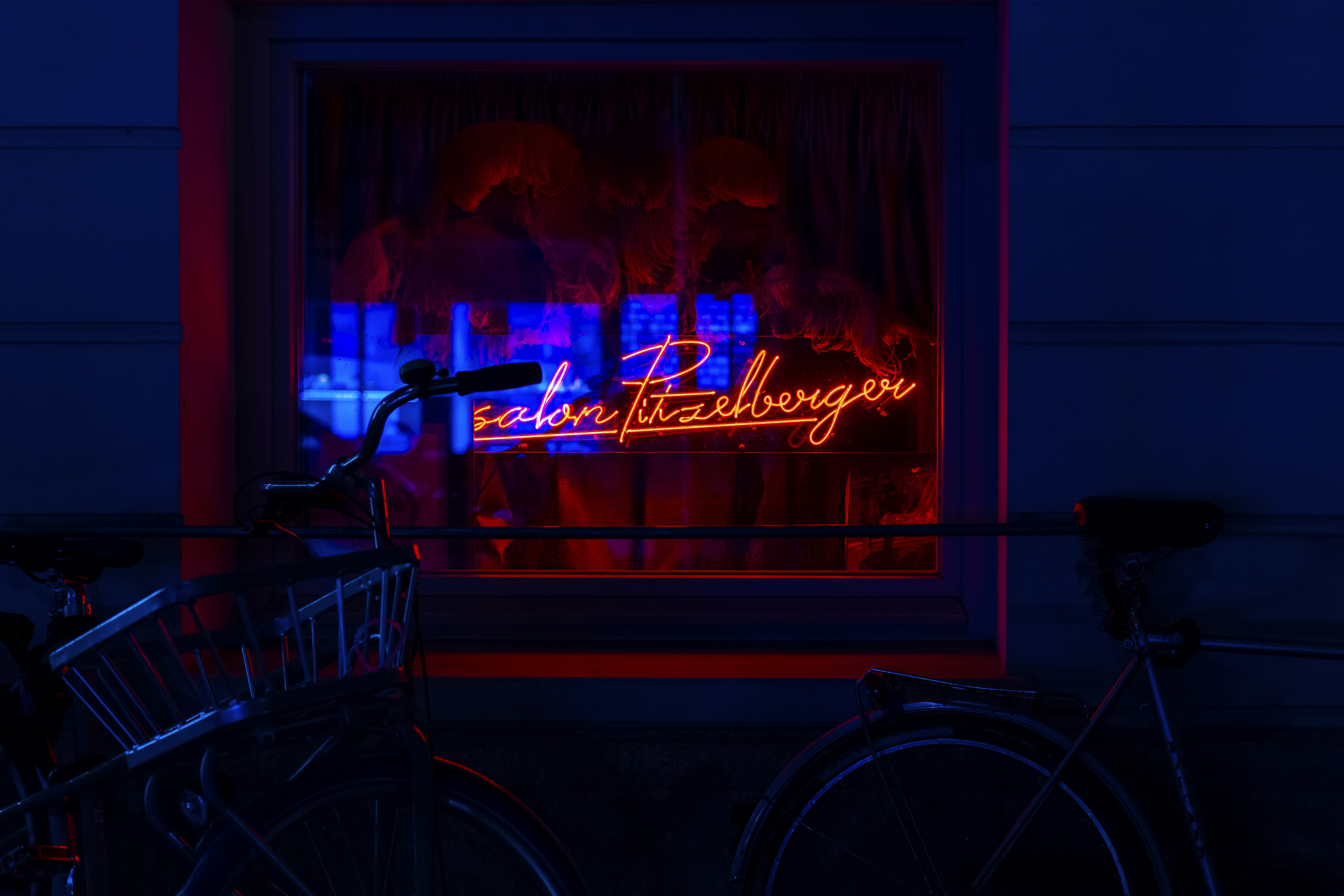 Neon Glimpse: Red-Bike Reflections in a Midnight Window