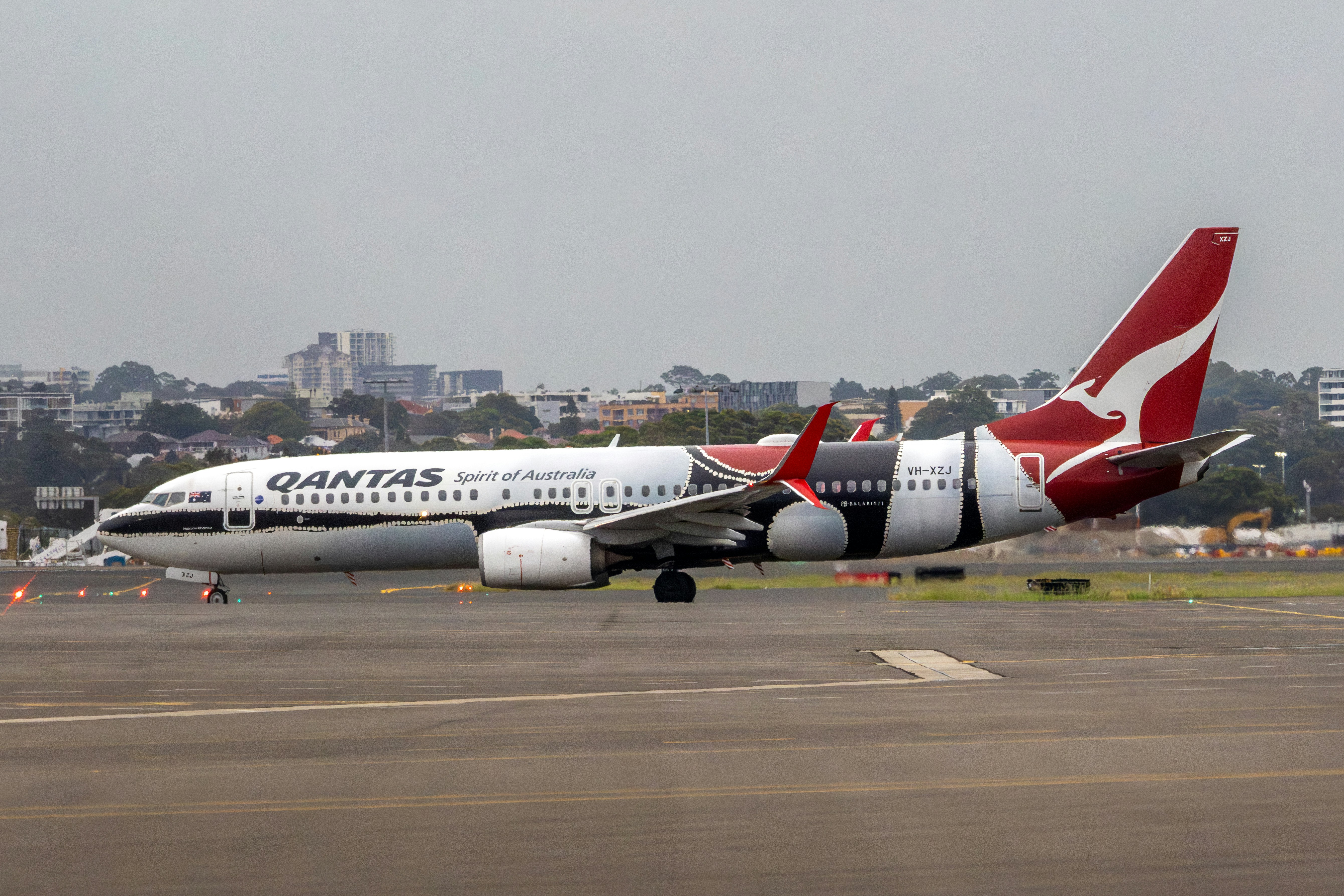 Qantas A330 on the tarmac: crisp livery and wing geometry in motion