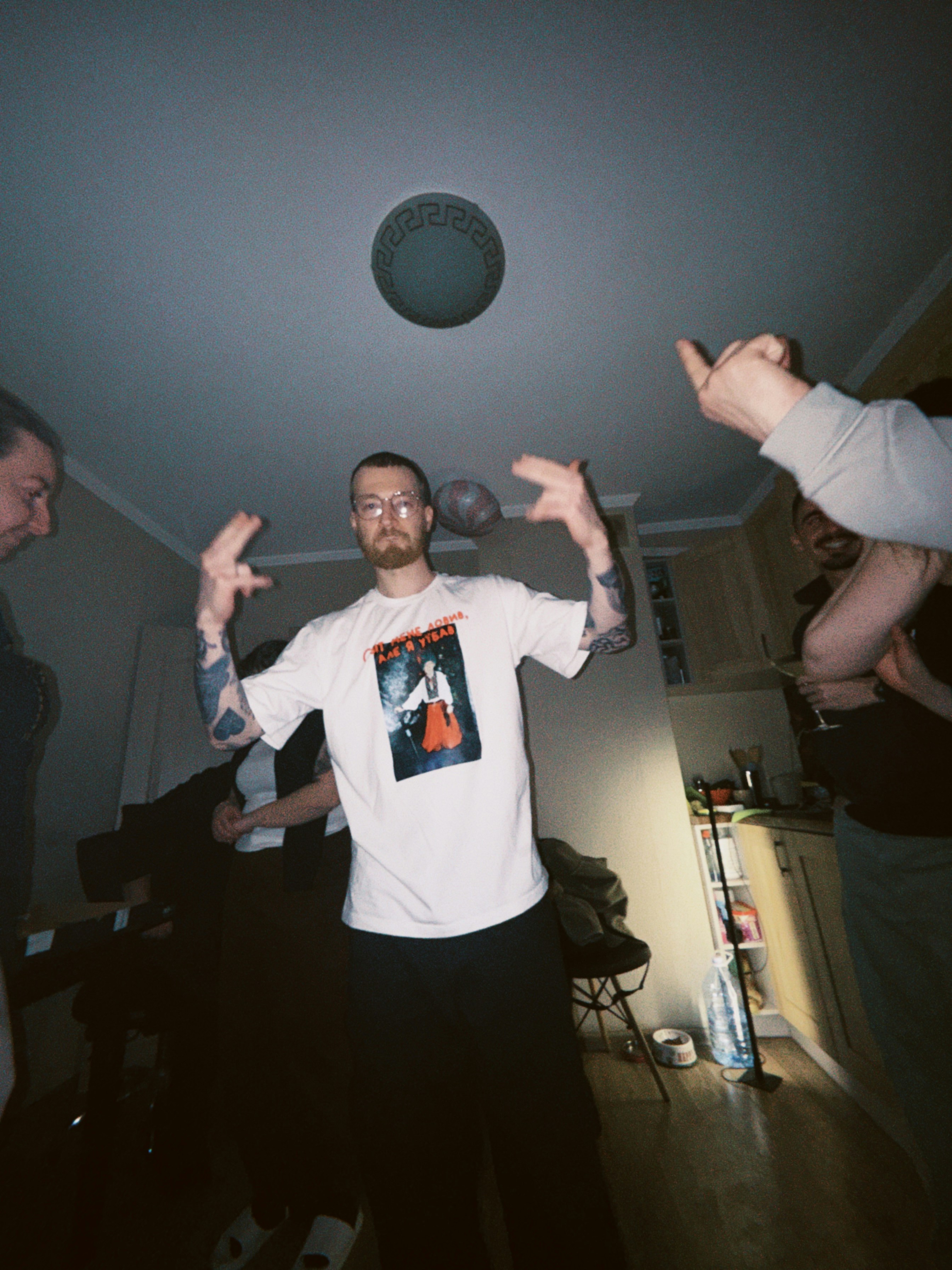 Midair Pose Under a Floating Ball: Night In a Cozy Kitchen