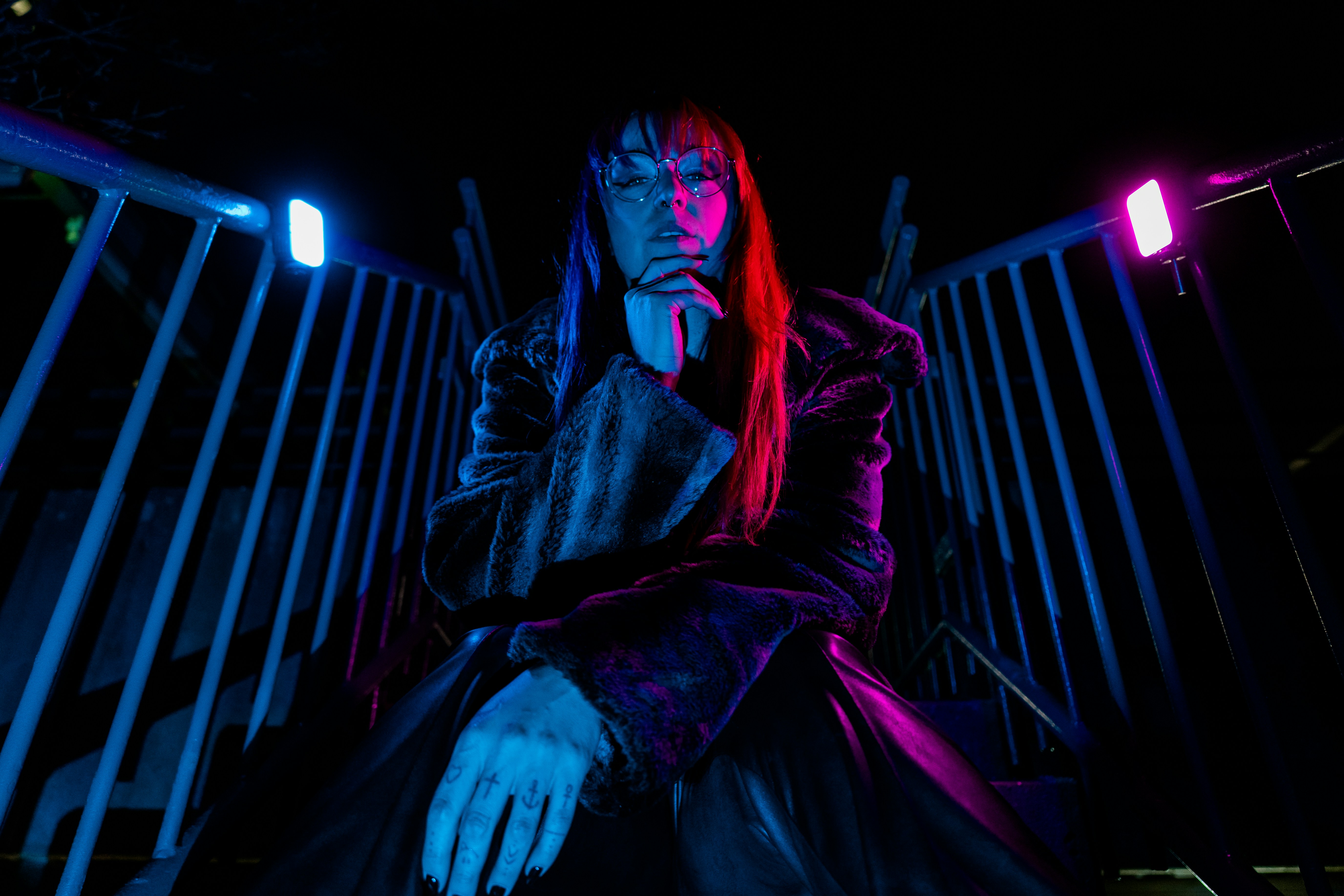Neon-gloom Portrait: A Pensive Figure Amid Blue-Red Night Lights