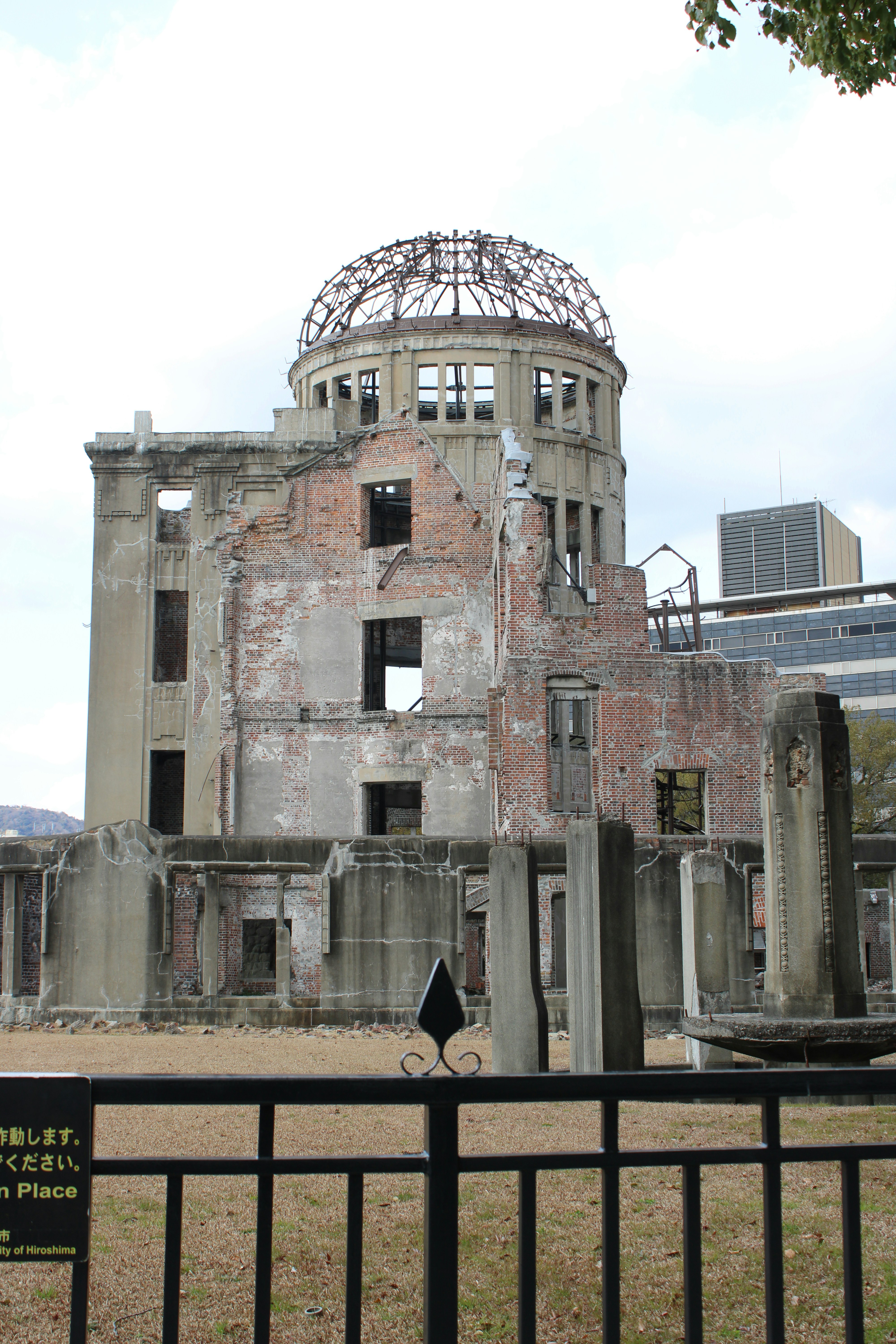Ruined Dome of Memory: A Crumbling World War II Structure Framed by Modern Skyscrapers