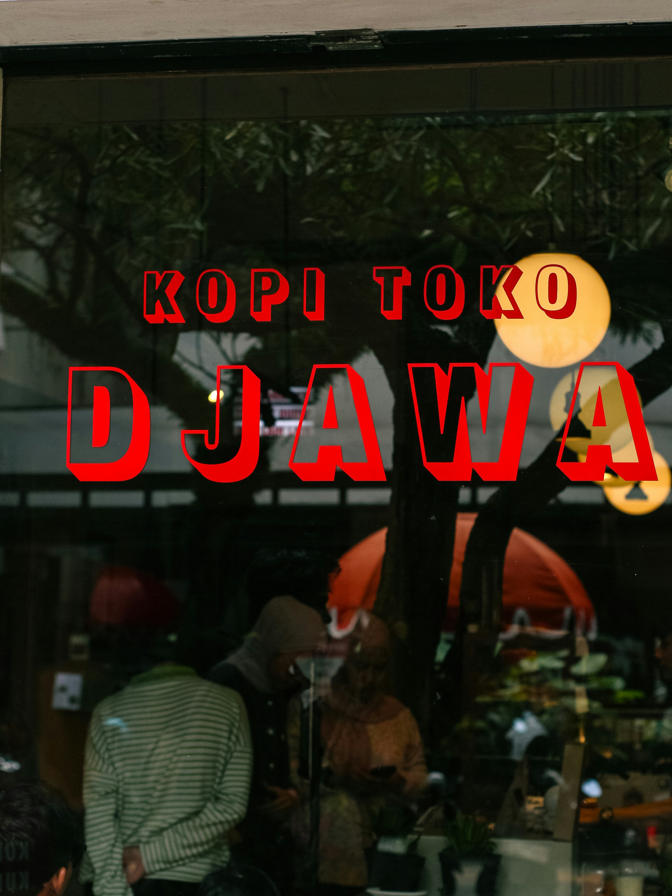 Red Neon Brand Overlay on a Café Window After Dark