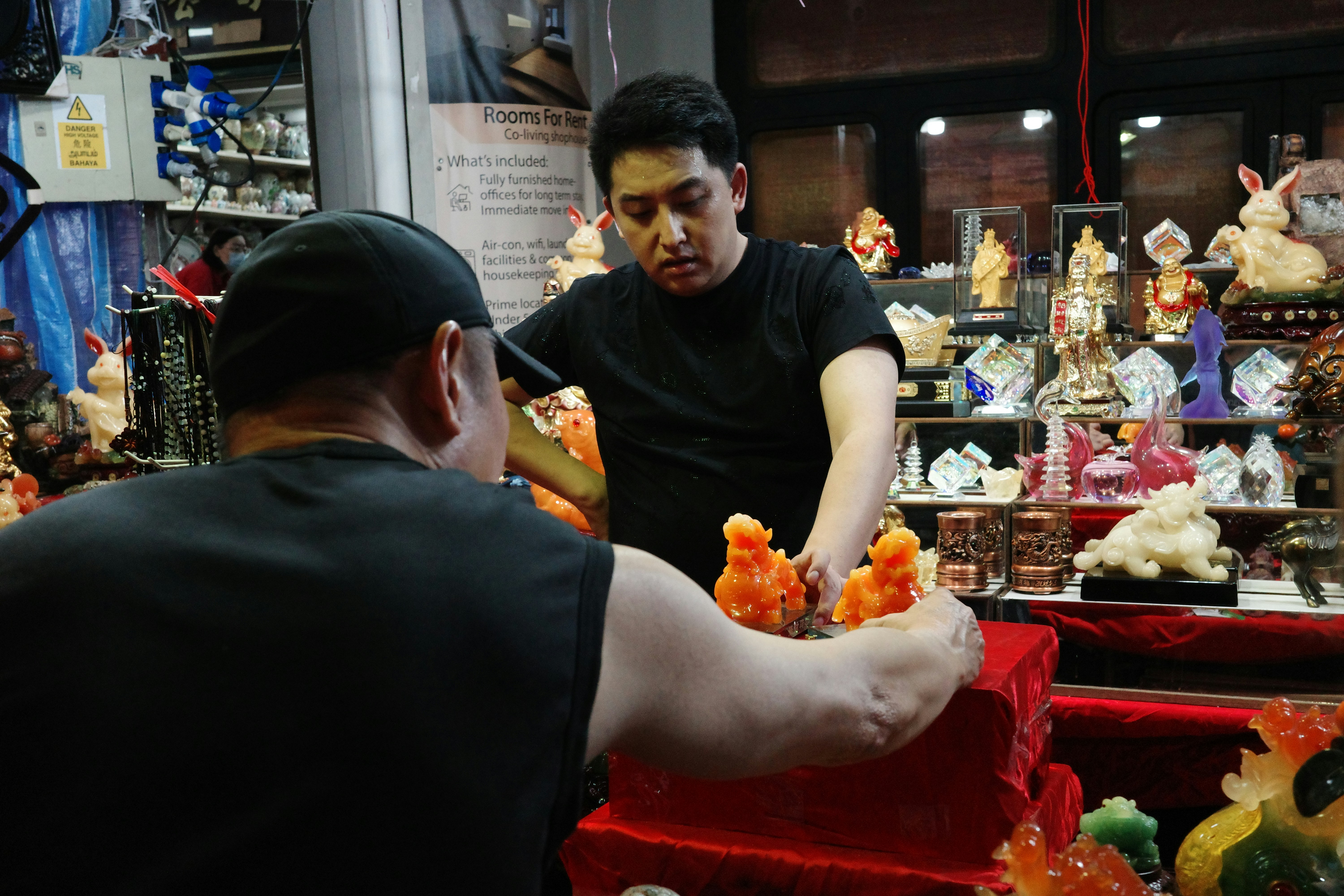 Hands in Action: Crafting Creations in a Bustling Market Stall