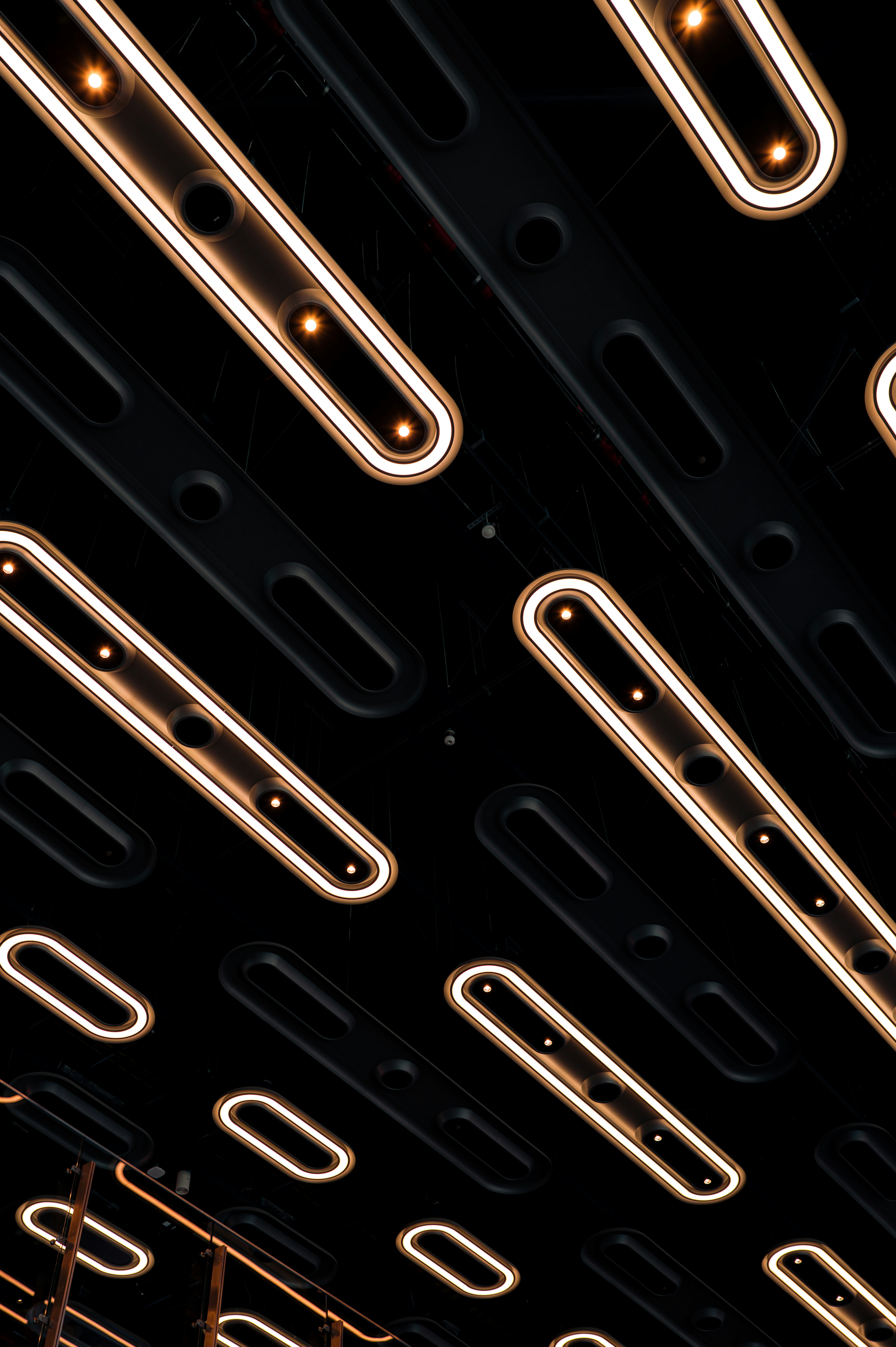 Neon Haloes Over a Dark Ceiling