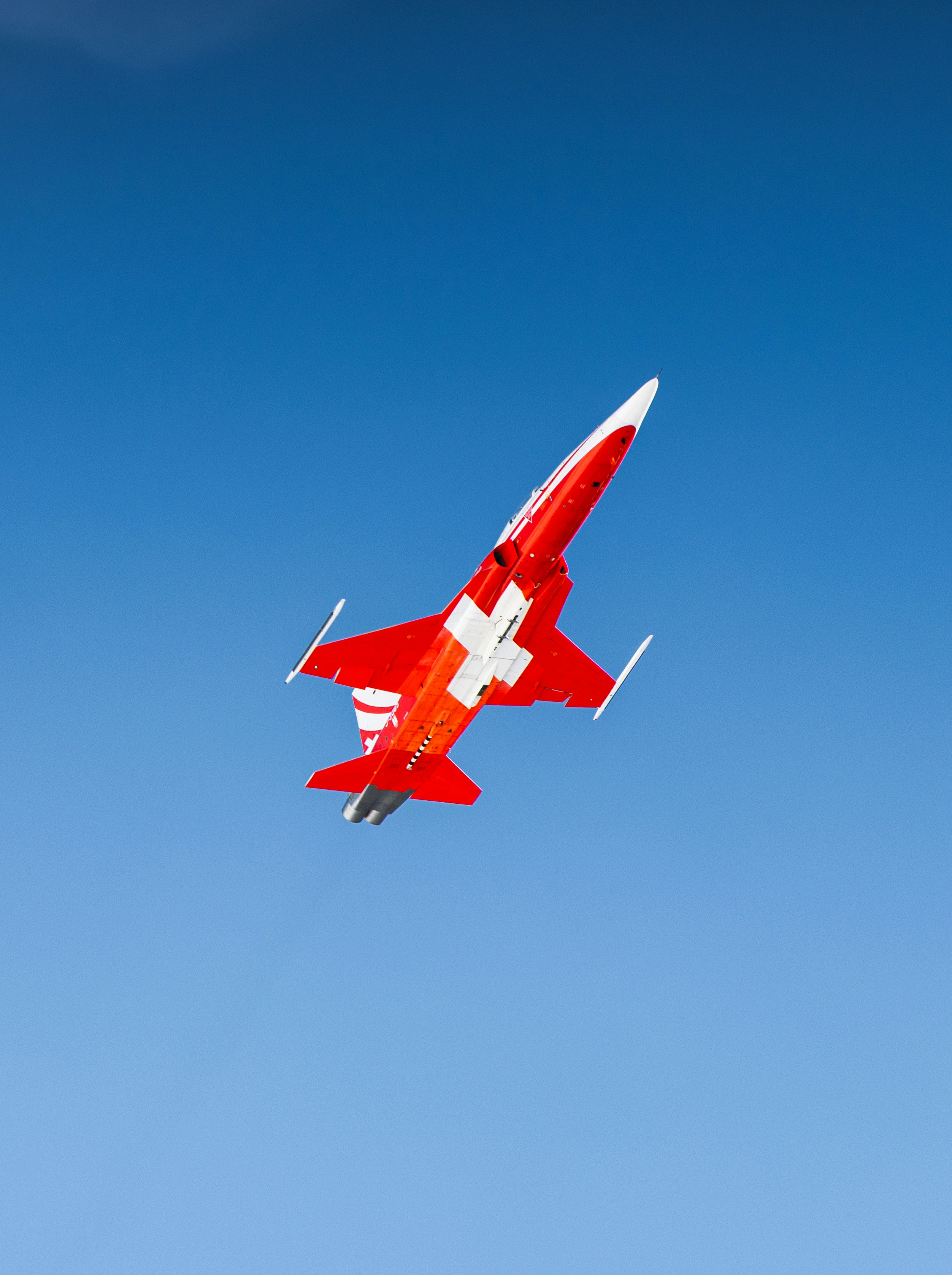Red Arrow in Flight: A Dynamic Tilt-Shift Arc in a Clear Sky
