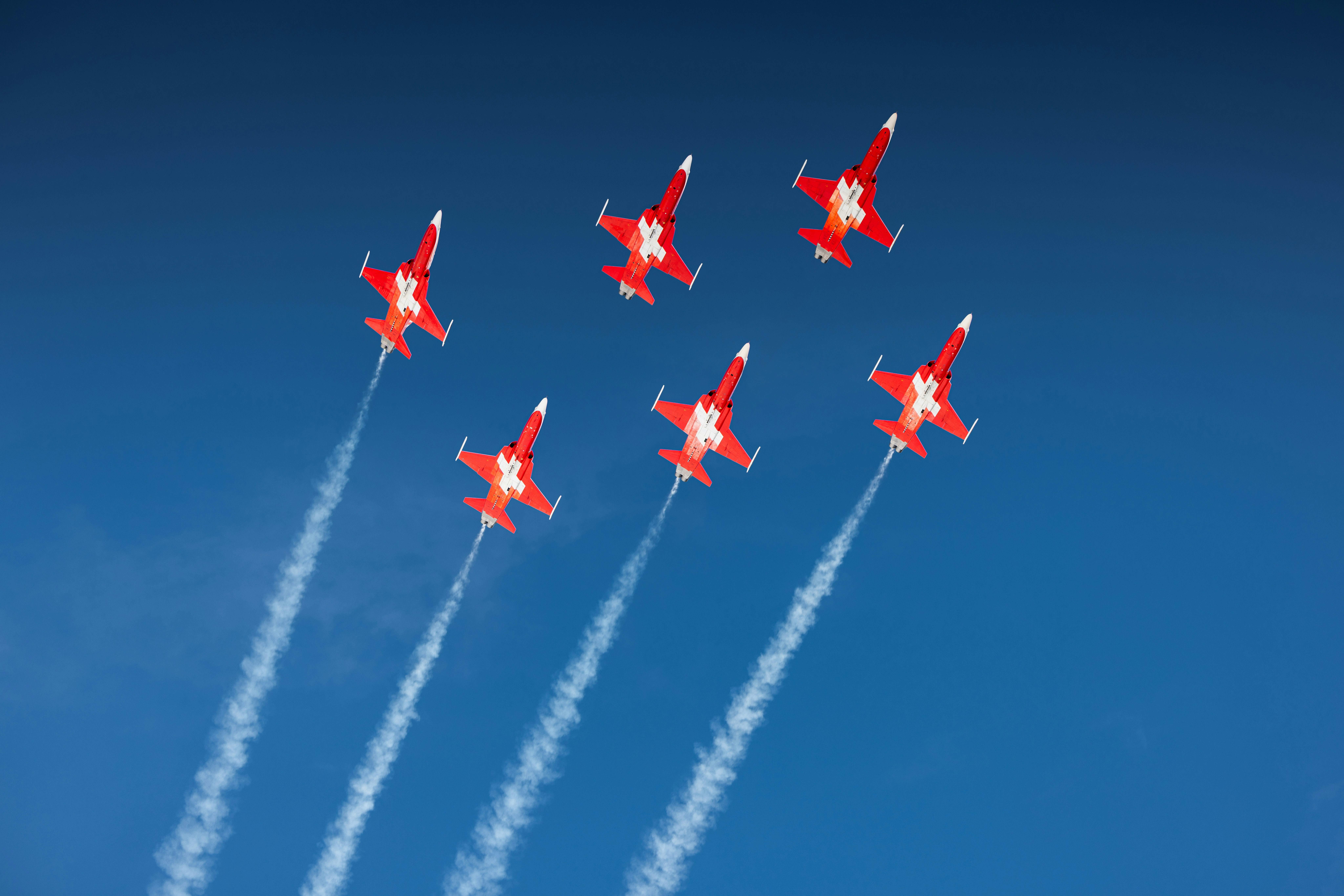 Six Red Jets Lean into a Sky-Blue Ascent