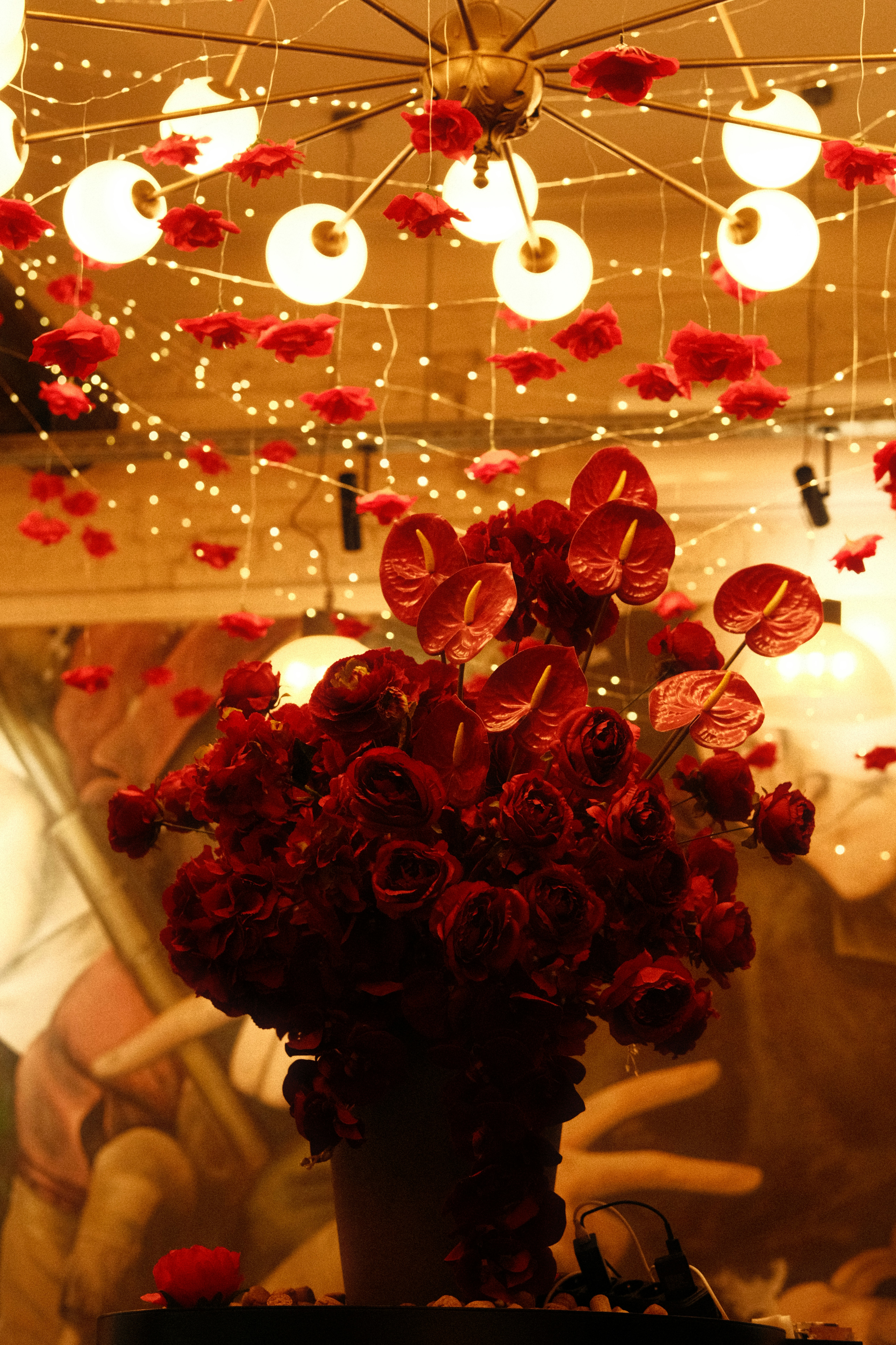 Red Bouquet Under Golden Festoon Lights