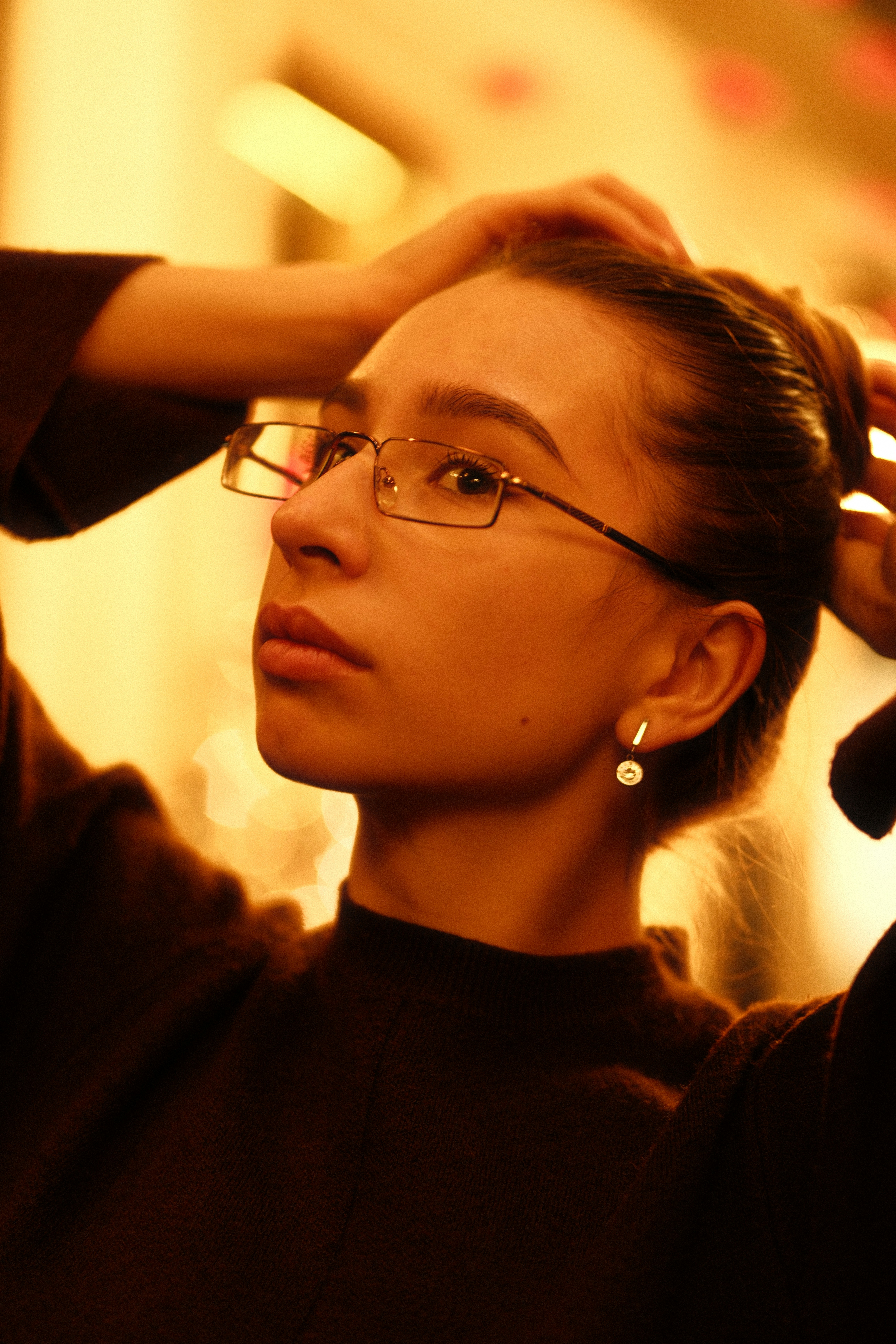 Glasses, posture, and warm glow: a portrait study in amber light