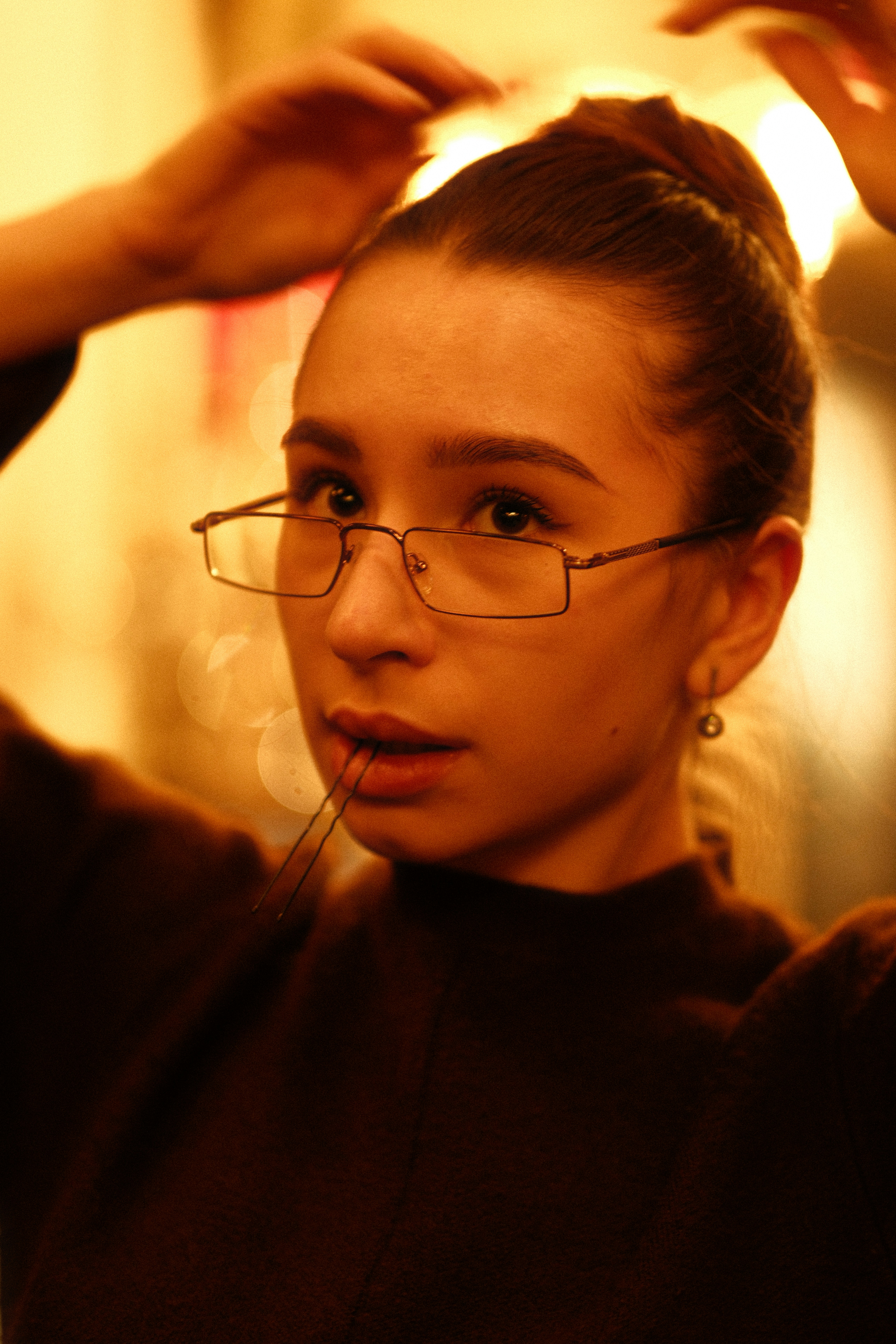 Glasses, Gaze, and Gesture: A Portrait in Warm Light