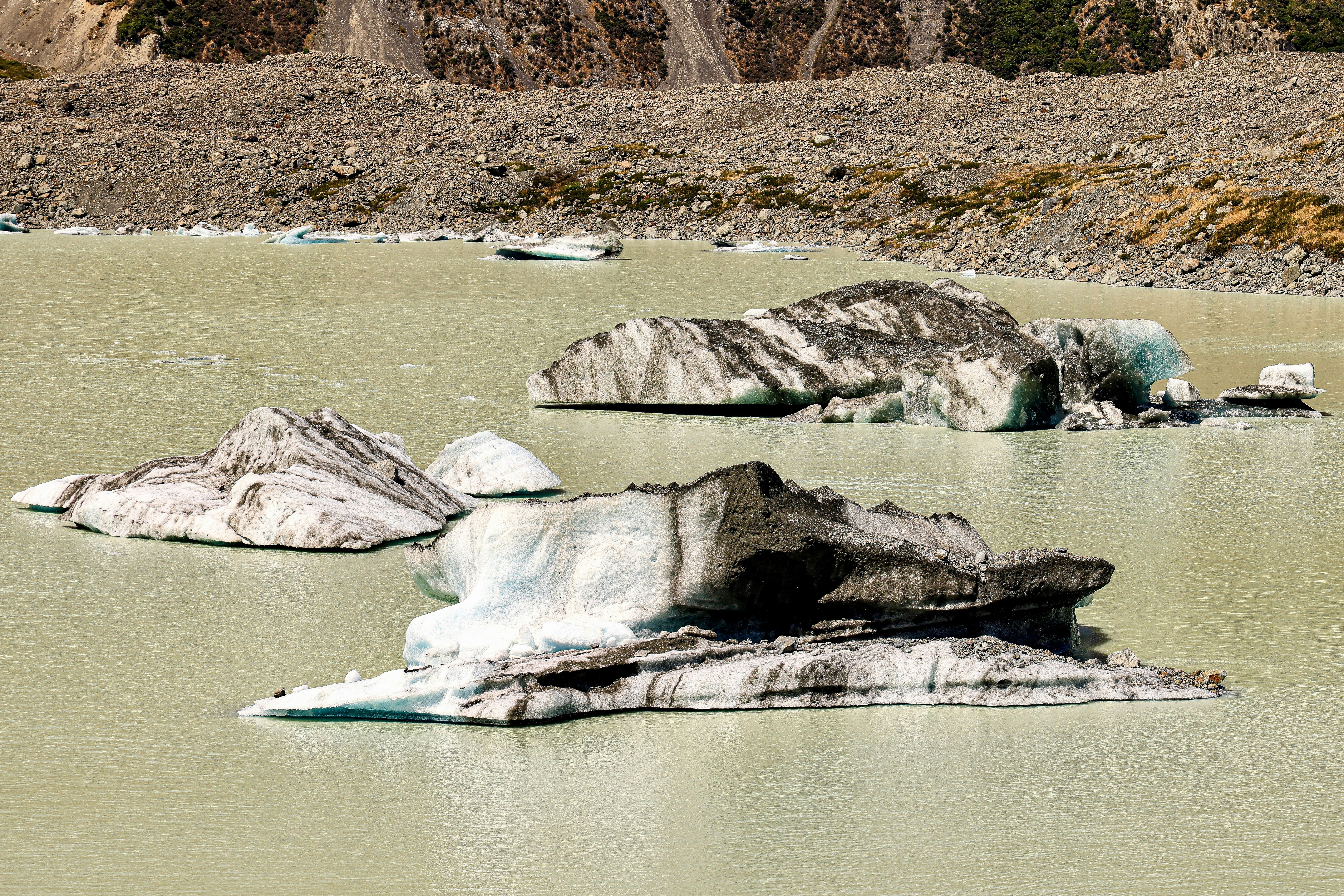 Floating ice in a pale-green alpine lake