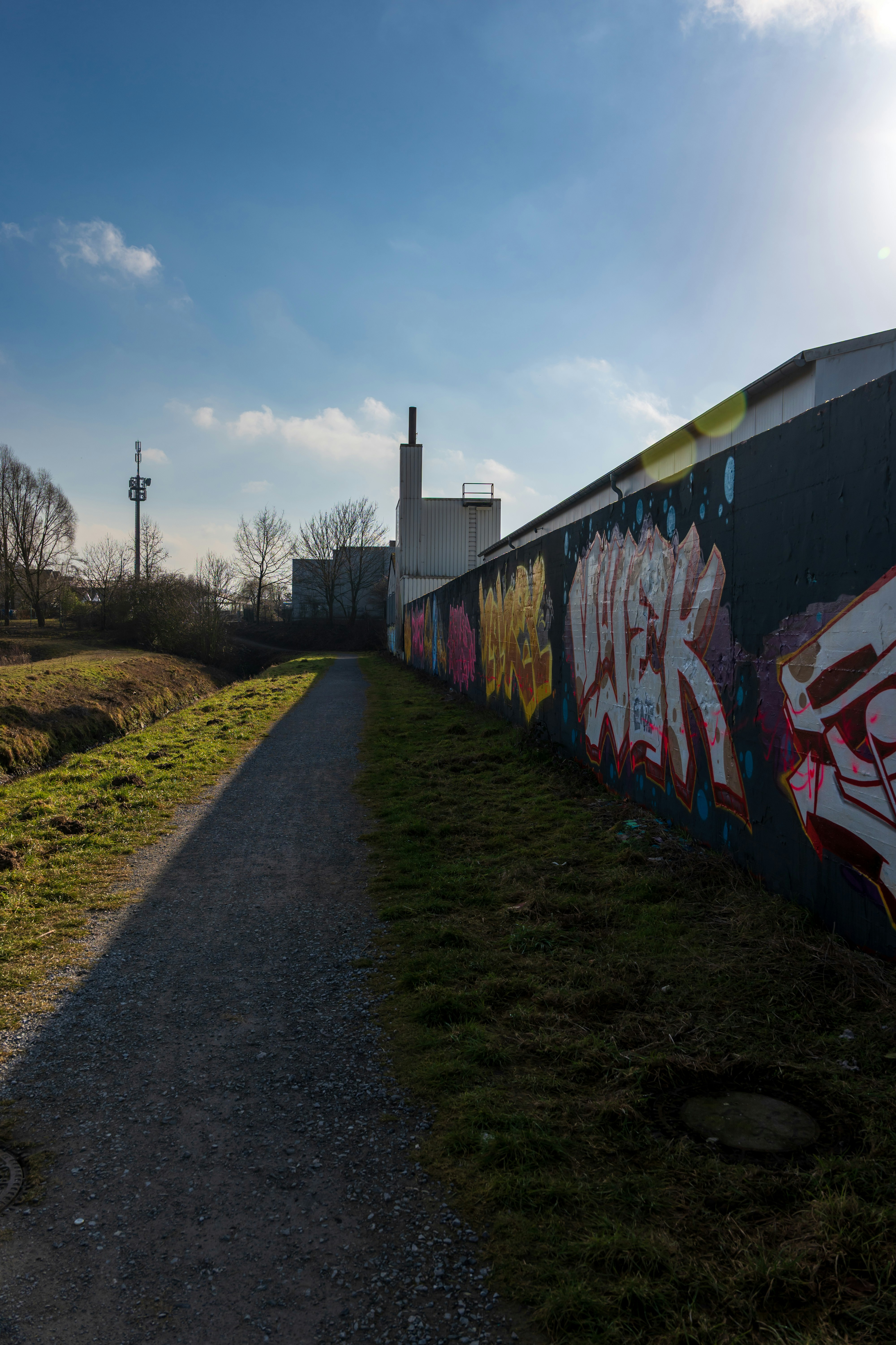 Graffiti Wall at Dusk: A Quiet Industrial Walkway