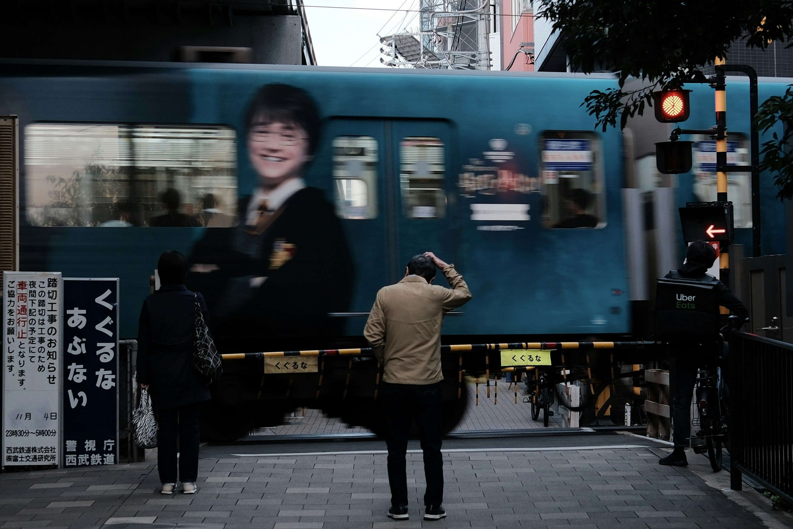 Blurred Blue Commuter: a candid street moment with a passing train