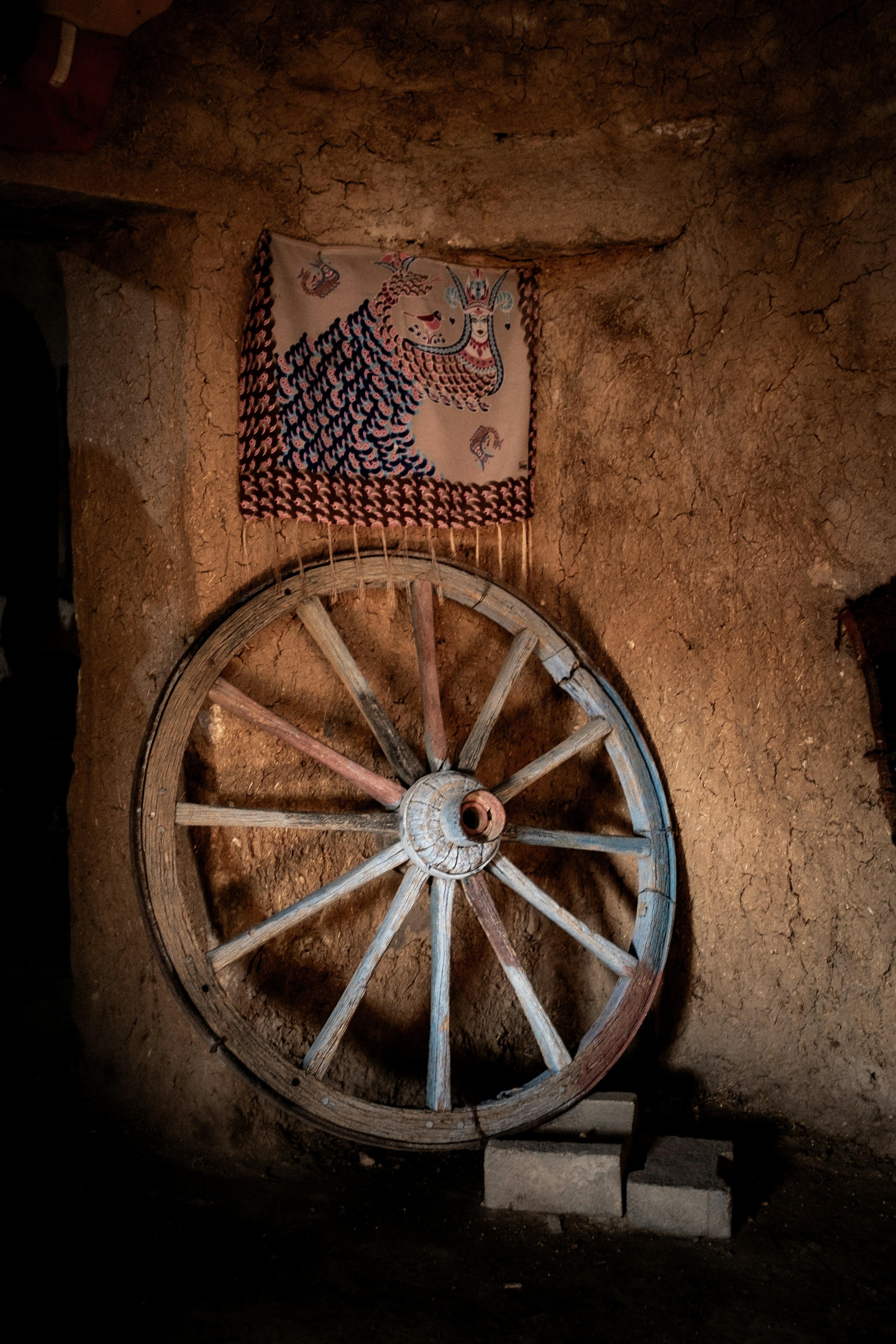 Ancient Wheel and Woven Banner: Echoes of a Rustic Workshop