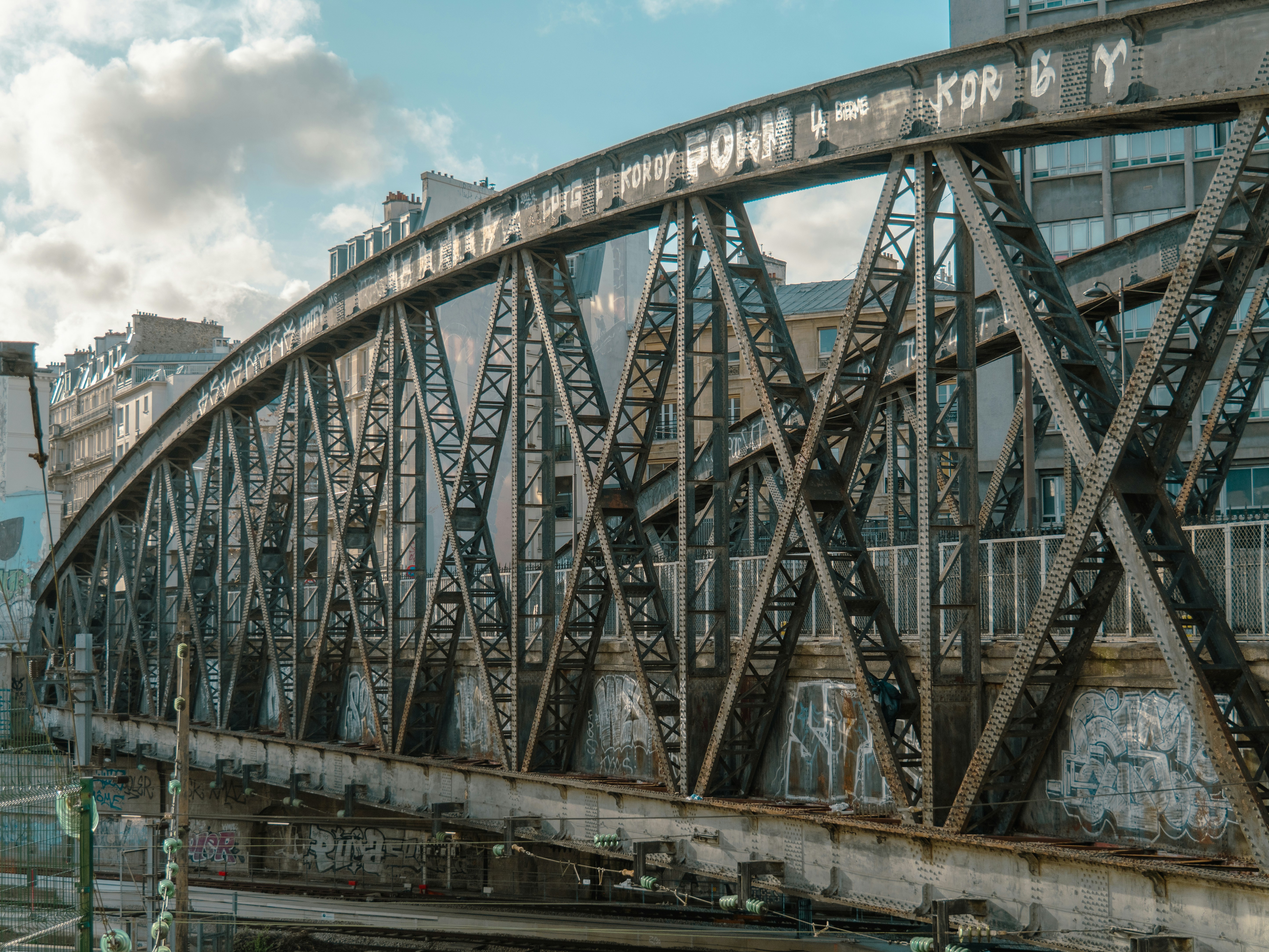 Graffiti-etched Iron Arc: An Urban Bridge Portrait